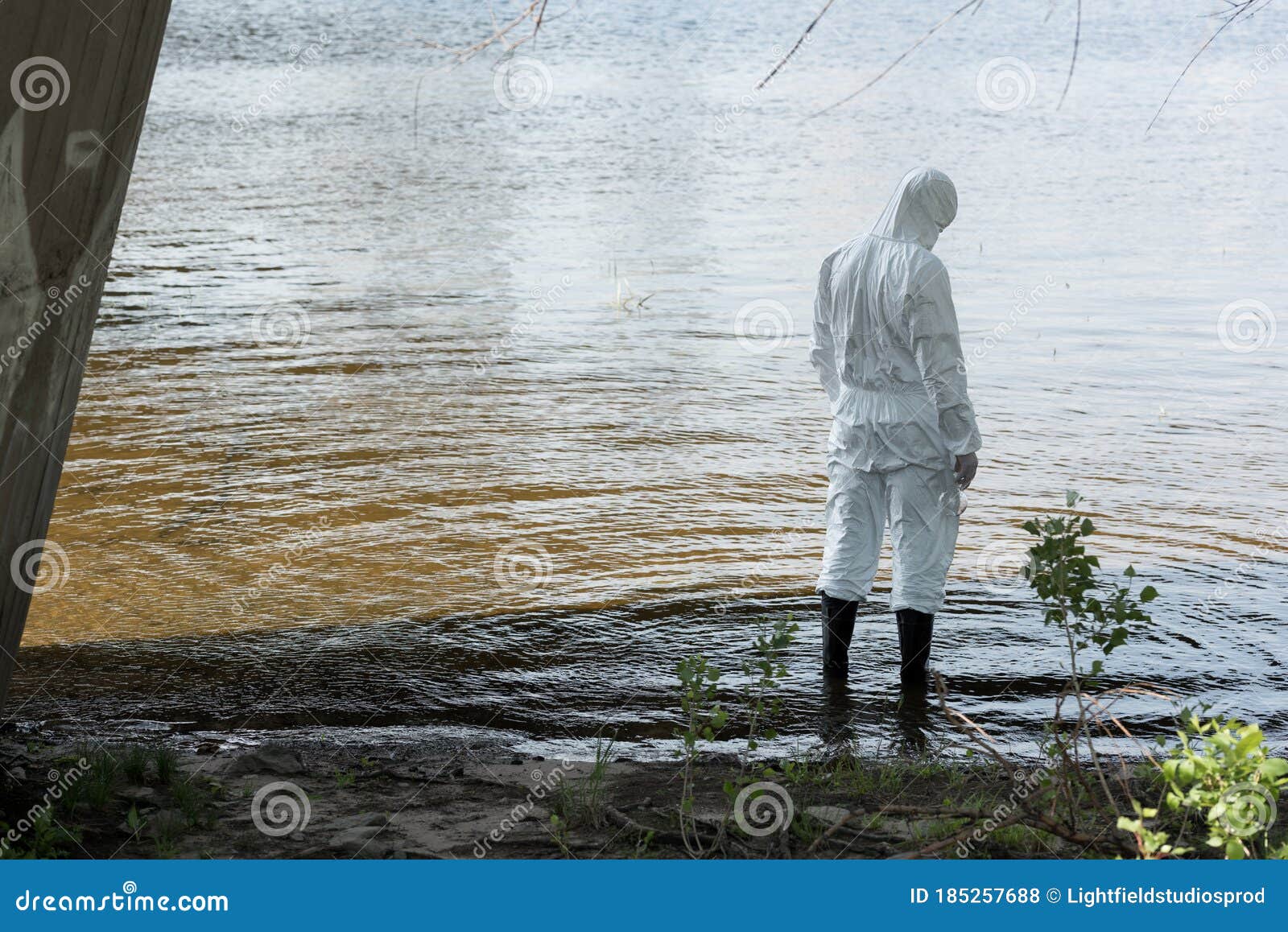 View of Water Inspector in Protective Costume Holding Flask while ...