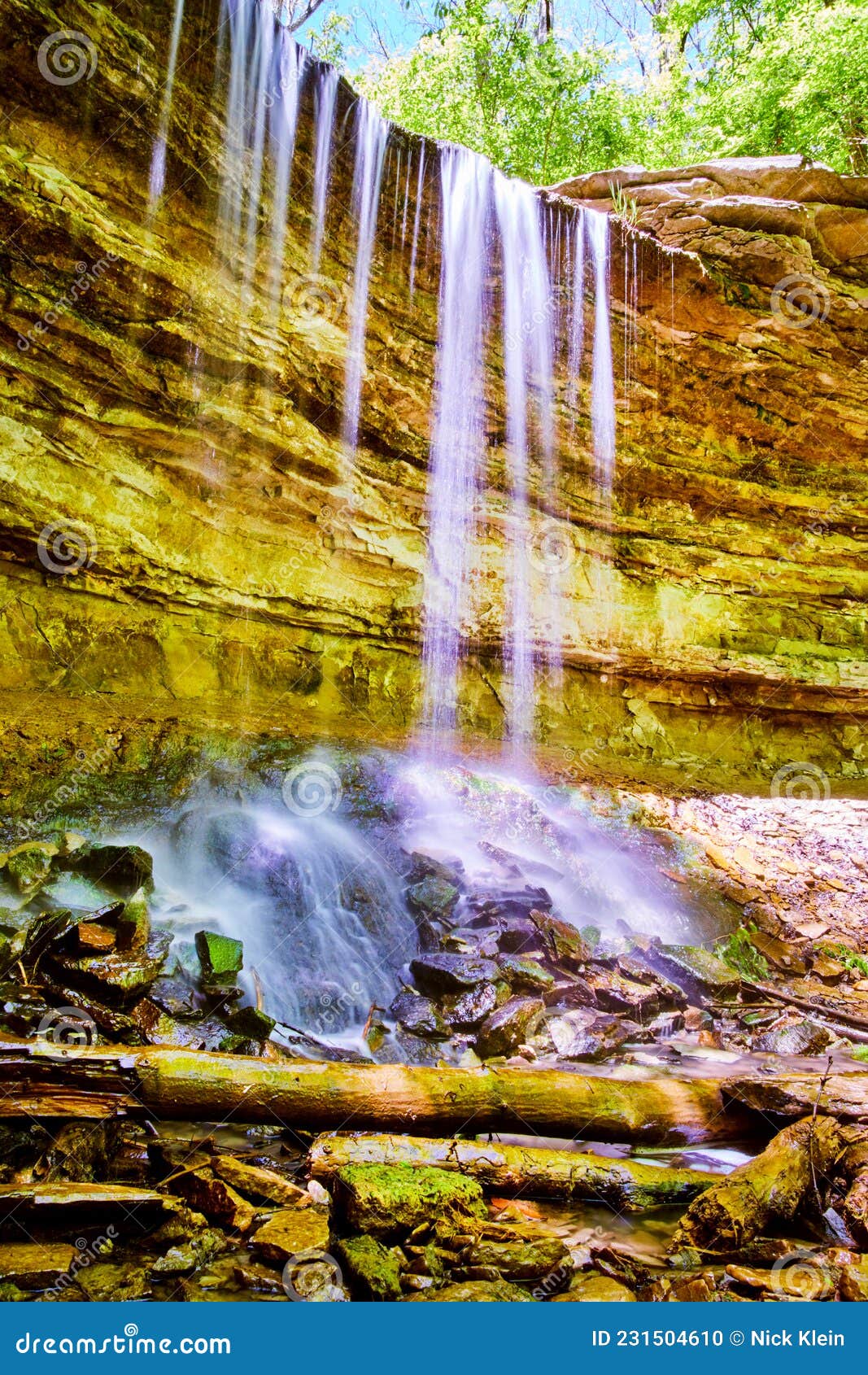 View of Waterfall Dripping Off of Cliffs Onto Rocks Stock Photo - Image ...