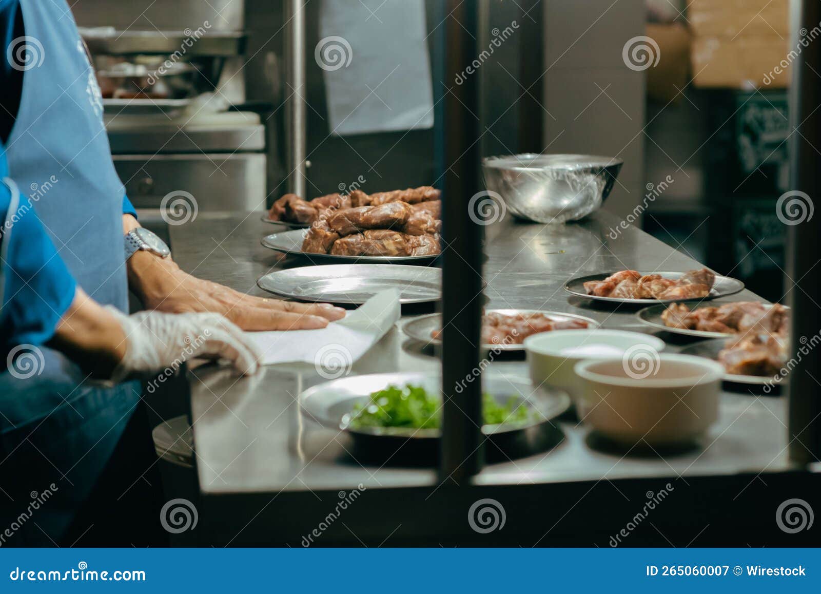 View through a Window of a Chef Preparing a Meal with Meat Stock Image ...