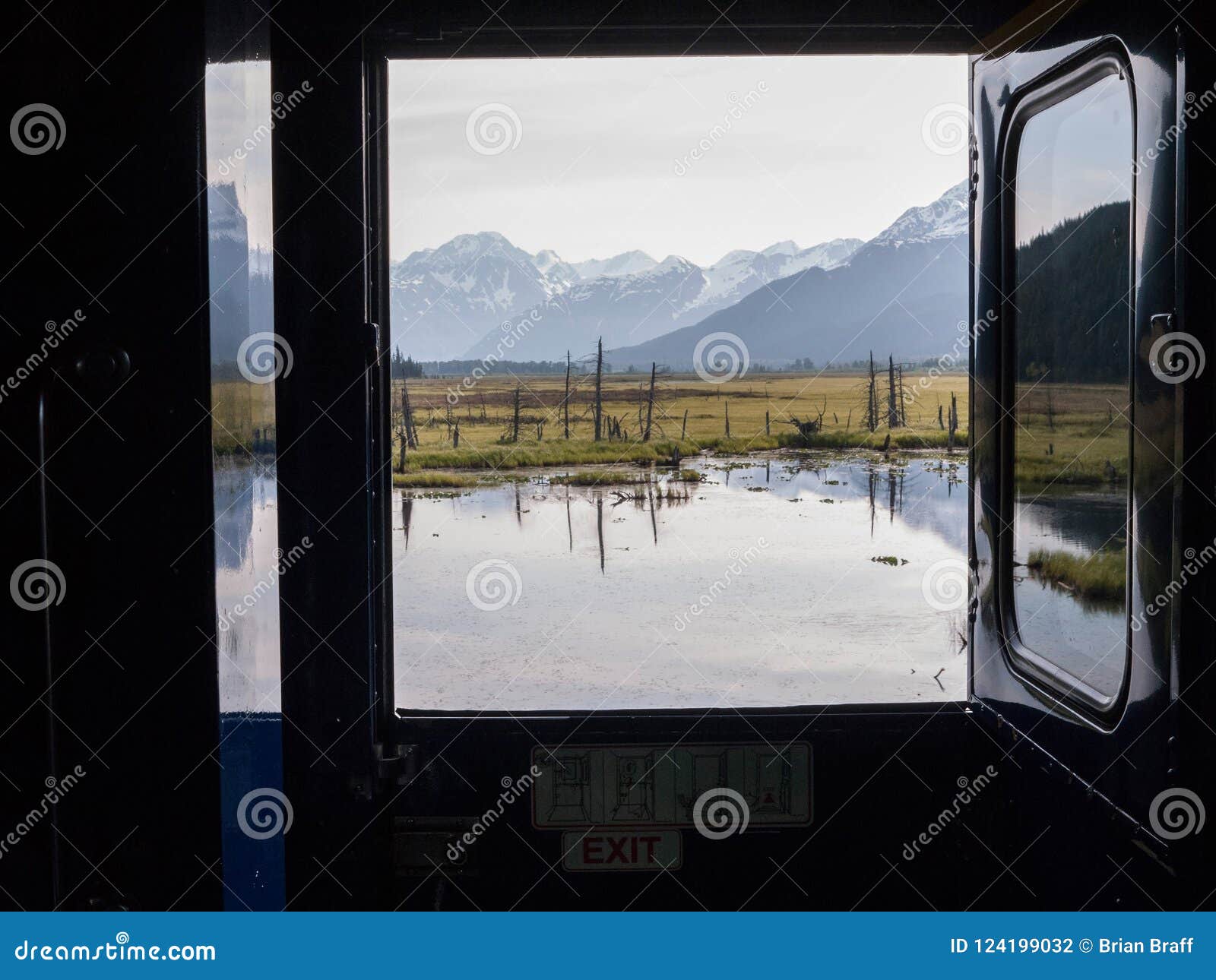 View from Window of Train in Alaska with Pond, Field and Snowcapped ...