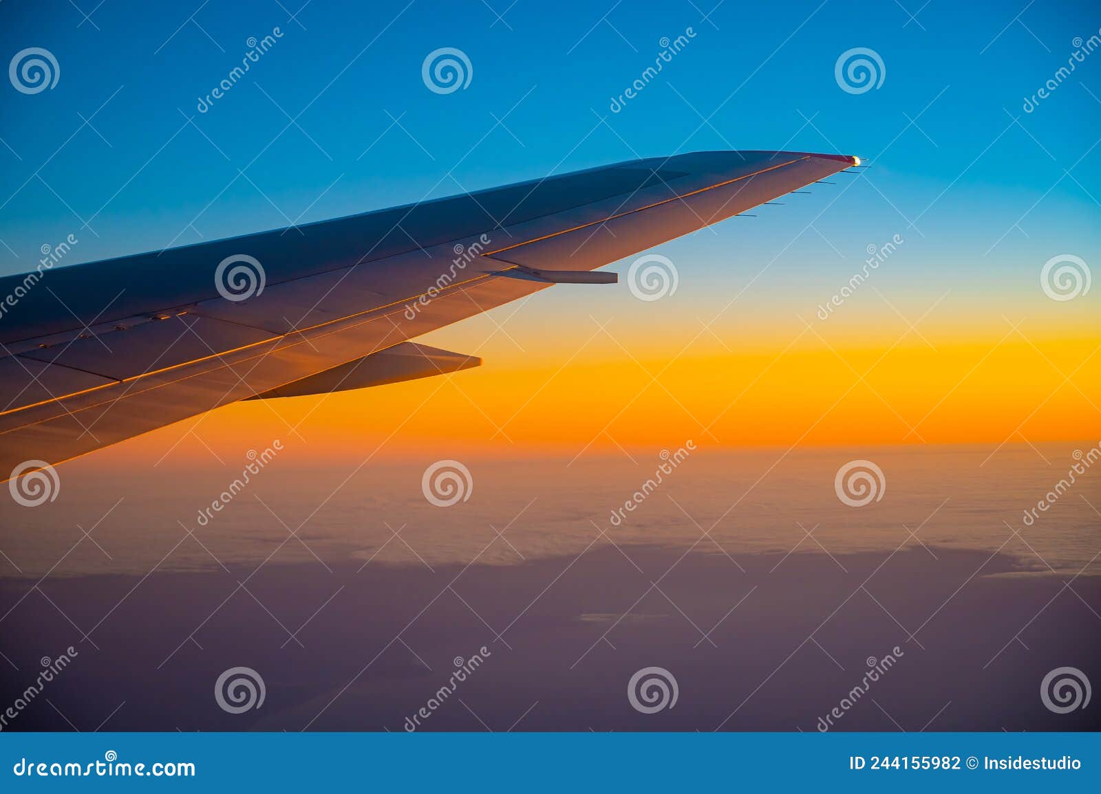 View of the Wing of an Airplane during Flight from the Window at Sunset ...