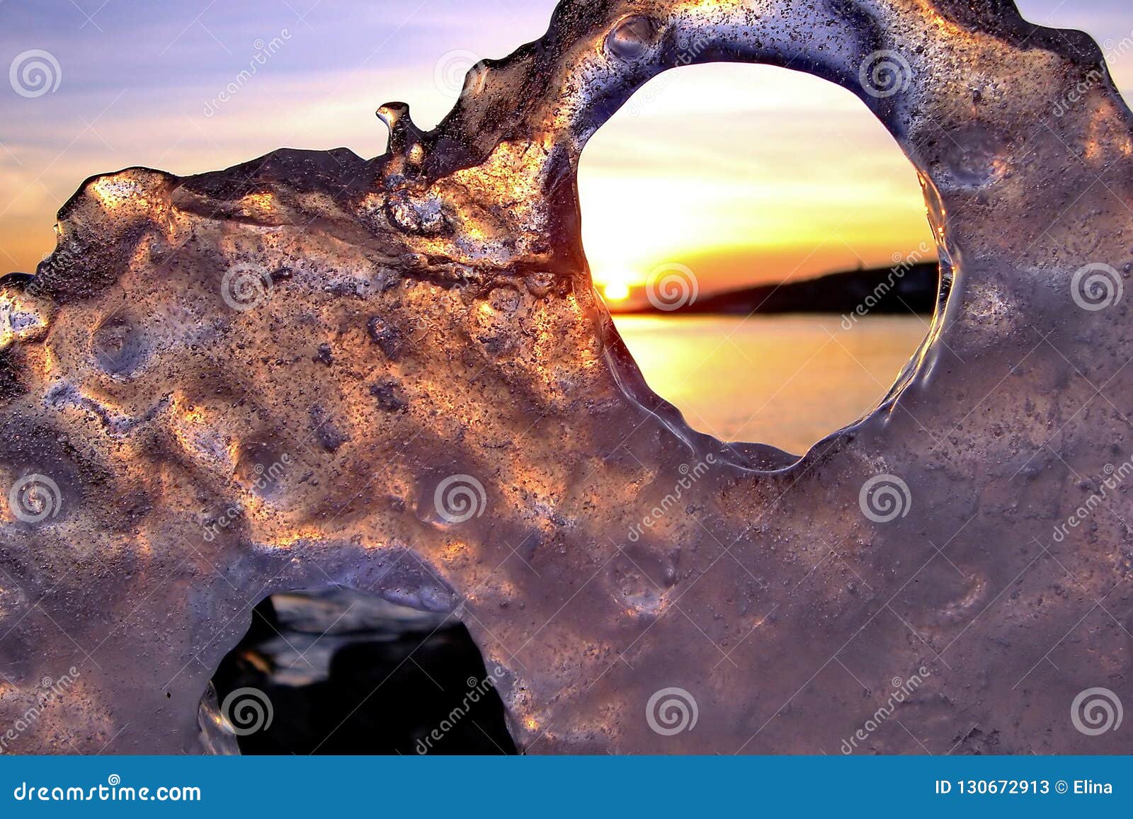 View of Winter Sunset through Holes in Ice Stock Image - Image of ...