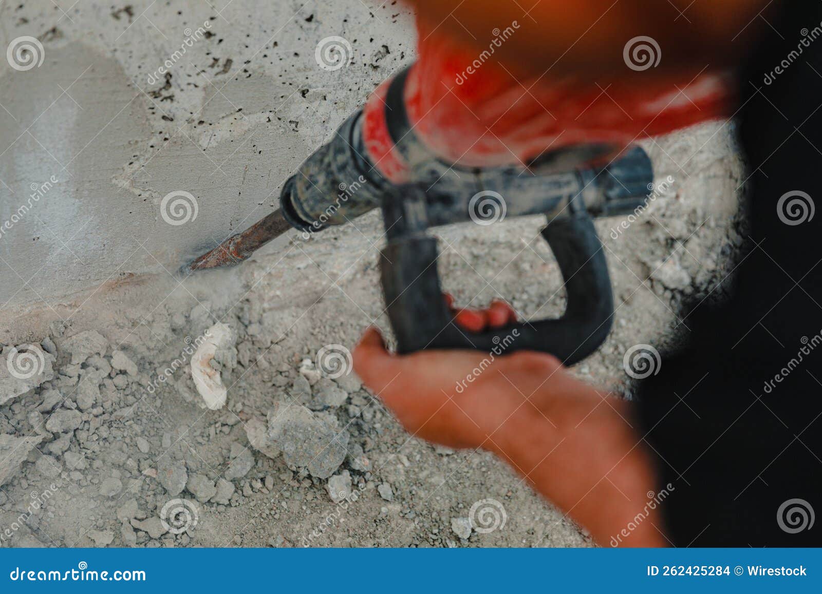 View of a Worker at a Construction Site Working with a Rock-drill and ...