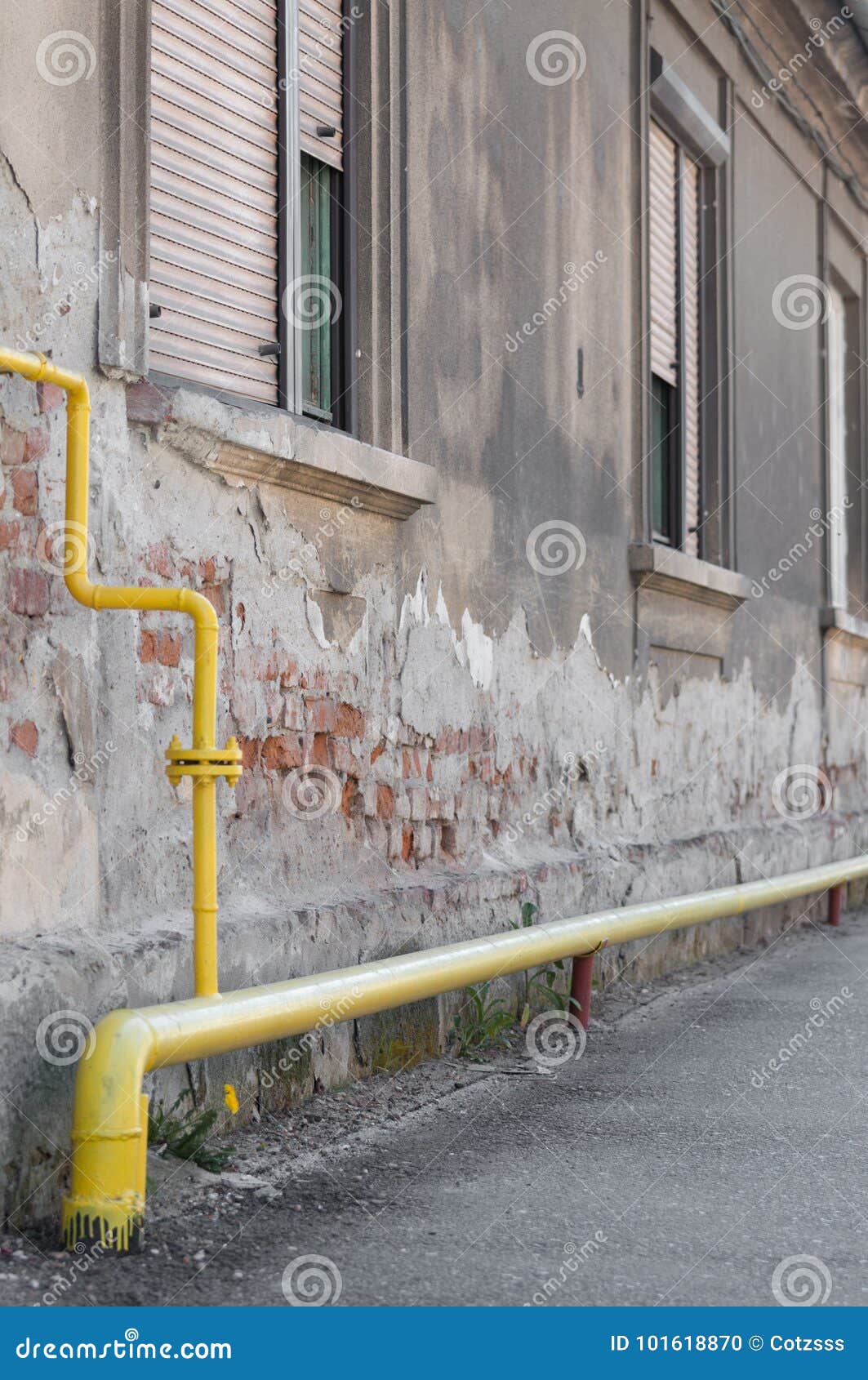 Yellow Pipe Connection and a House with Shuttered Windows Stock Photo ...