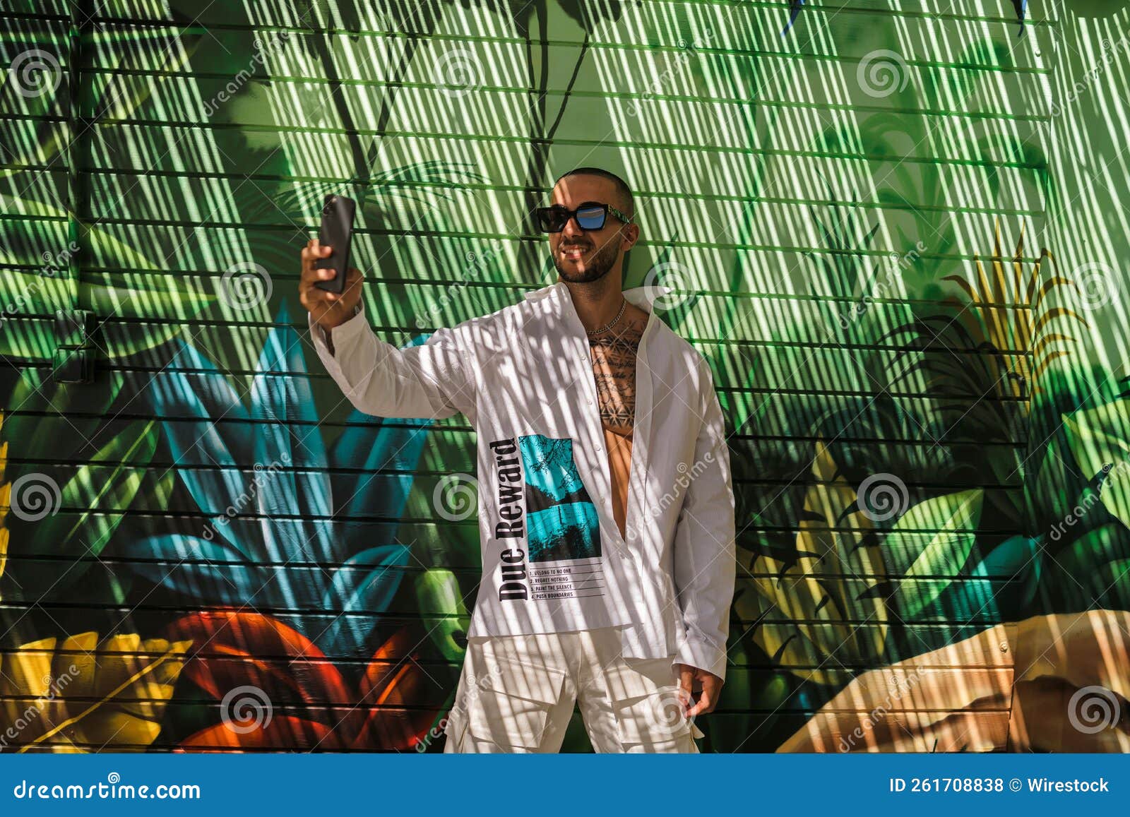 View of the Young, Spanish Man Posing with Palm Tree Shadows on Him and ...