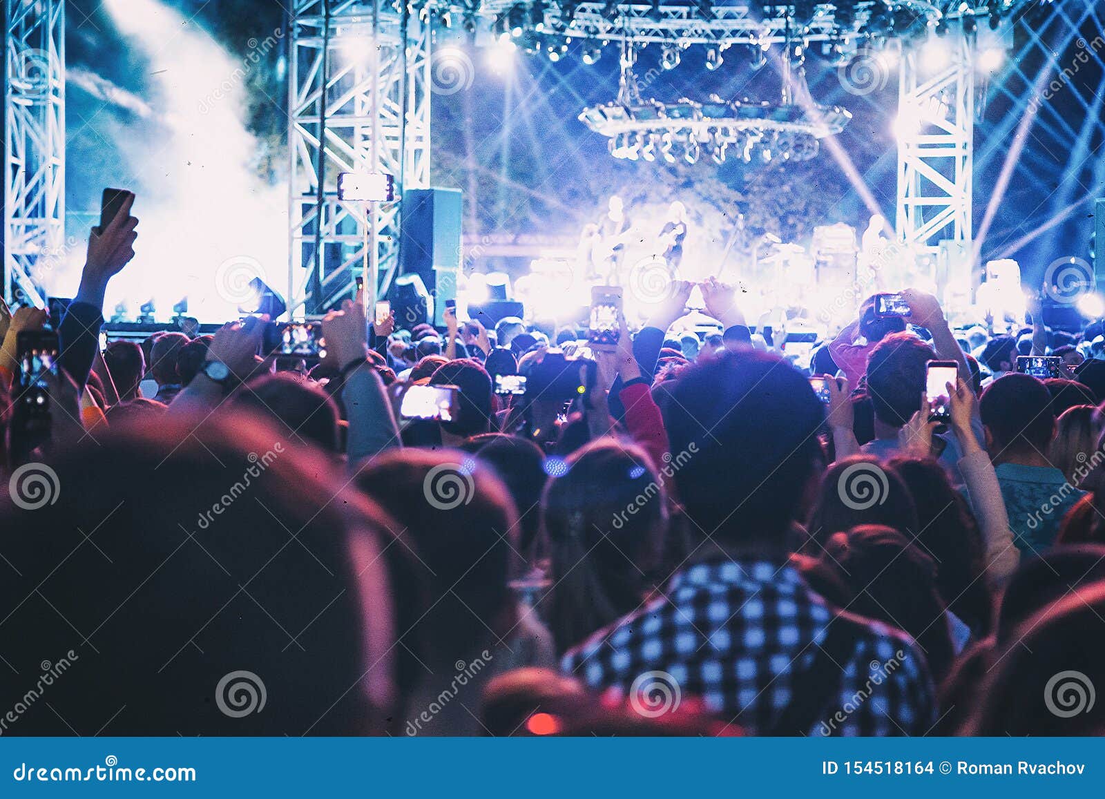 Viewers Watch a Rock Band Perform on Stage. Stock Photo - Image of ...