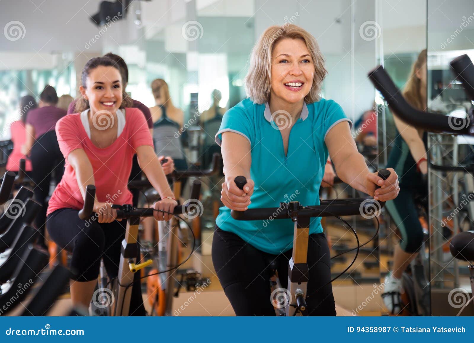 Vigorous Females of Different Age Training on Exercise Bikes Stock ...