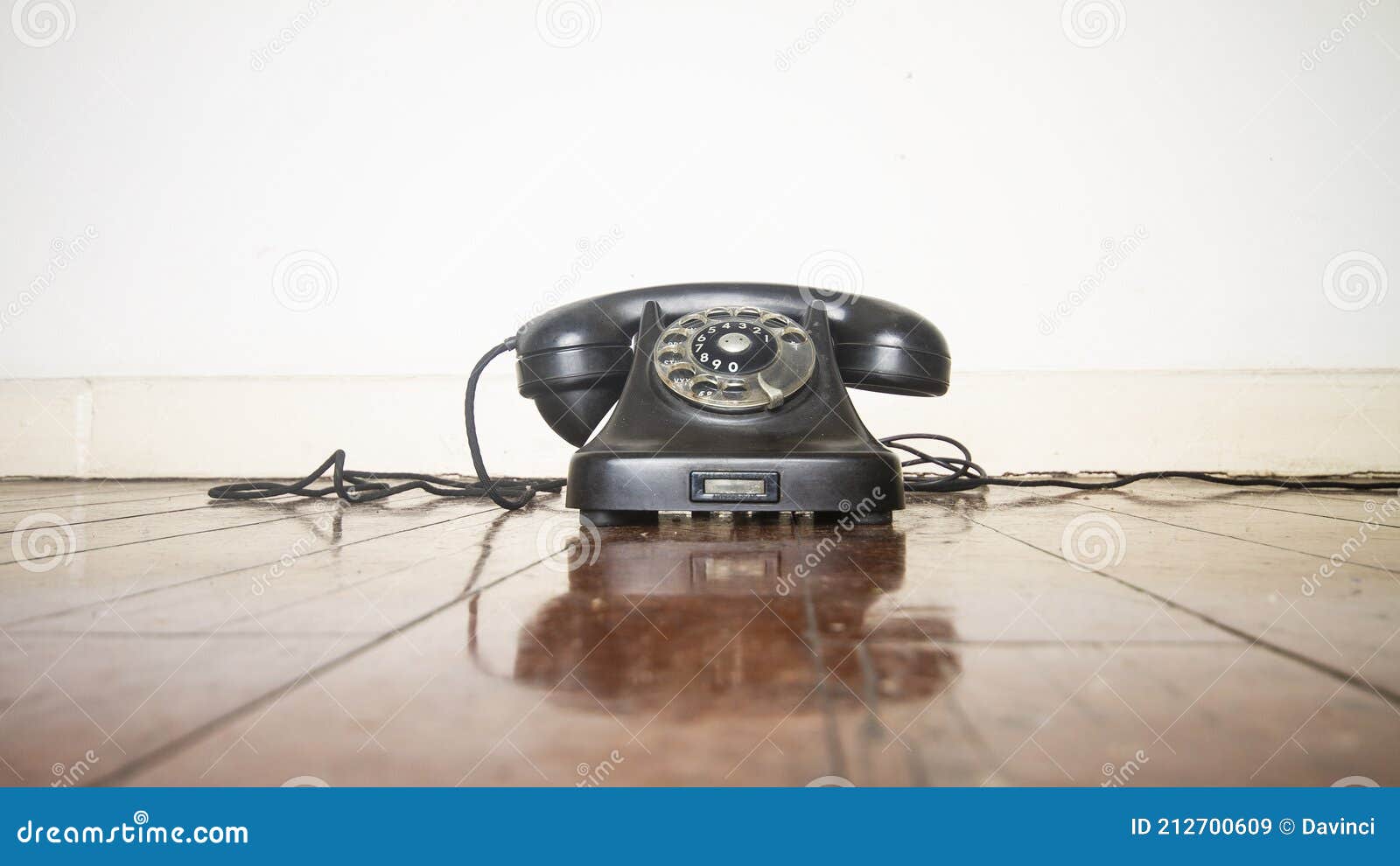 A Vintage Black Phone Ringing Off the Hook on a Wooden Floor Stock ...