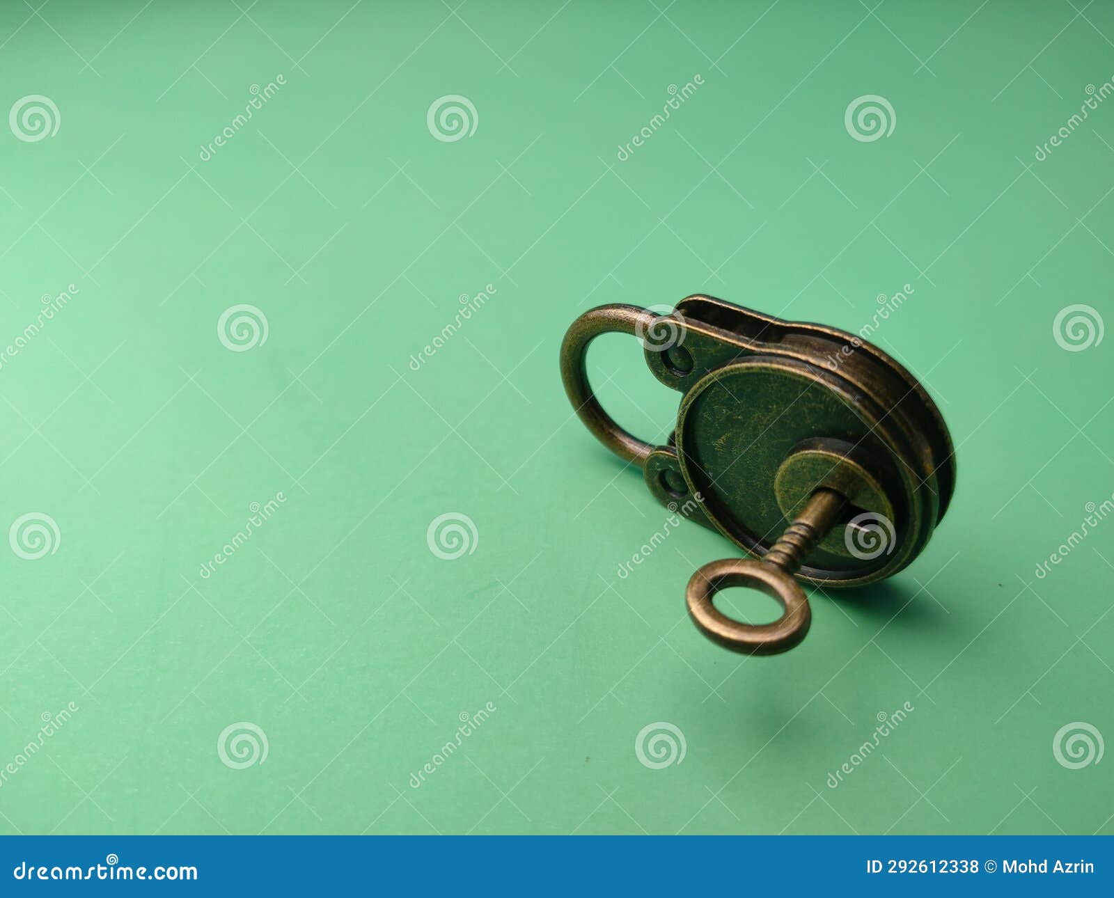 Vintage Bronze Key and Padlock on Soft Green Paper Stock Photo - Image ...
