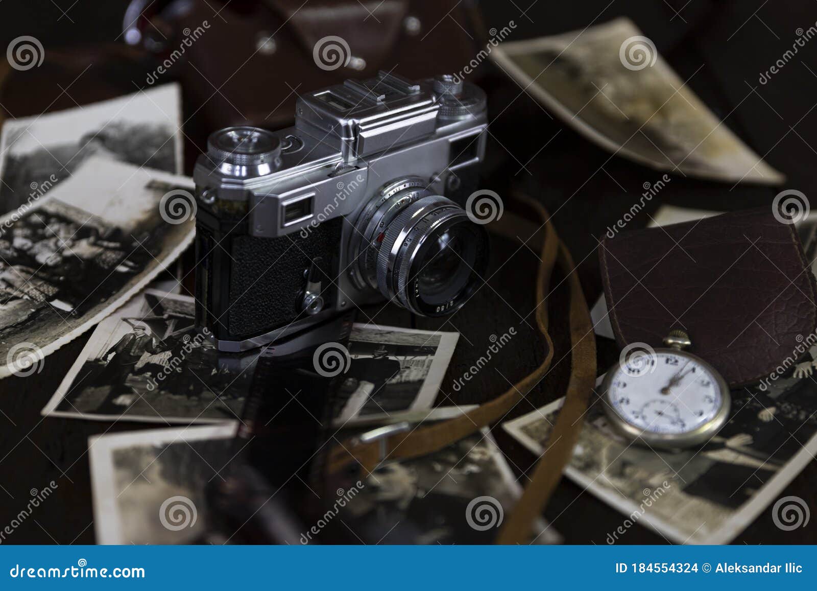 Vintage Film Camera and Old Photographs on a Rustic Surface Editorial ...
