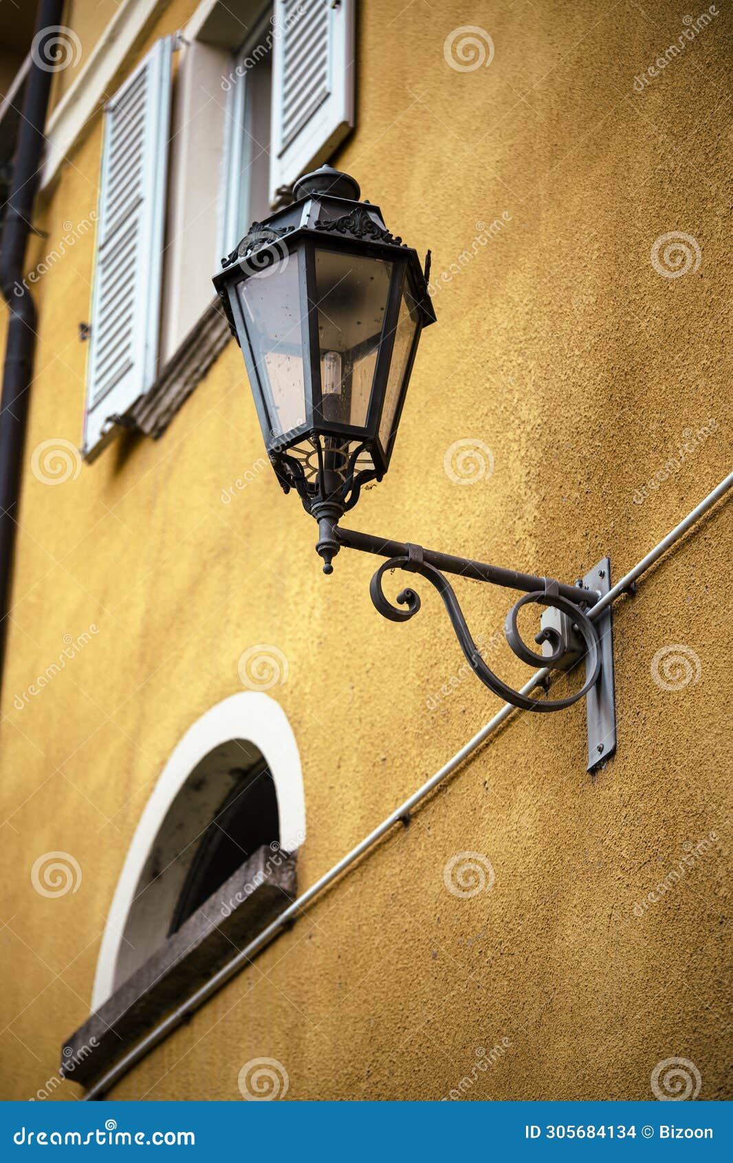 Vintage Lamp Post on a Building Wall Stock Photo - Image of high, steel ...