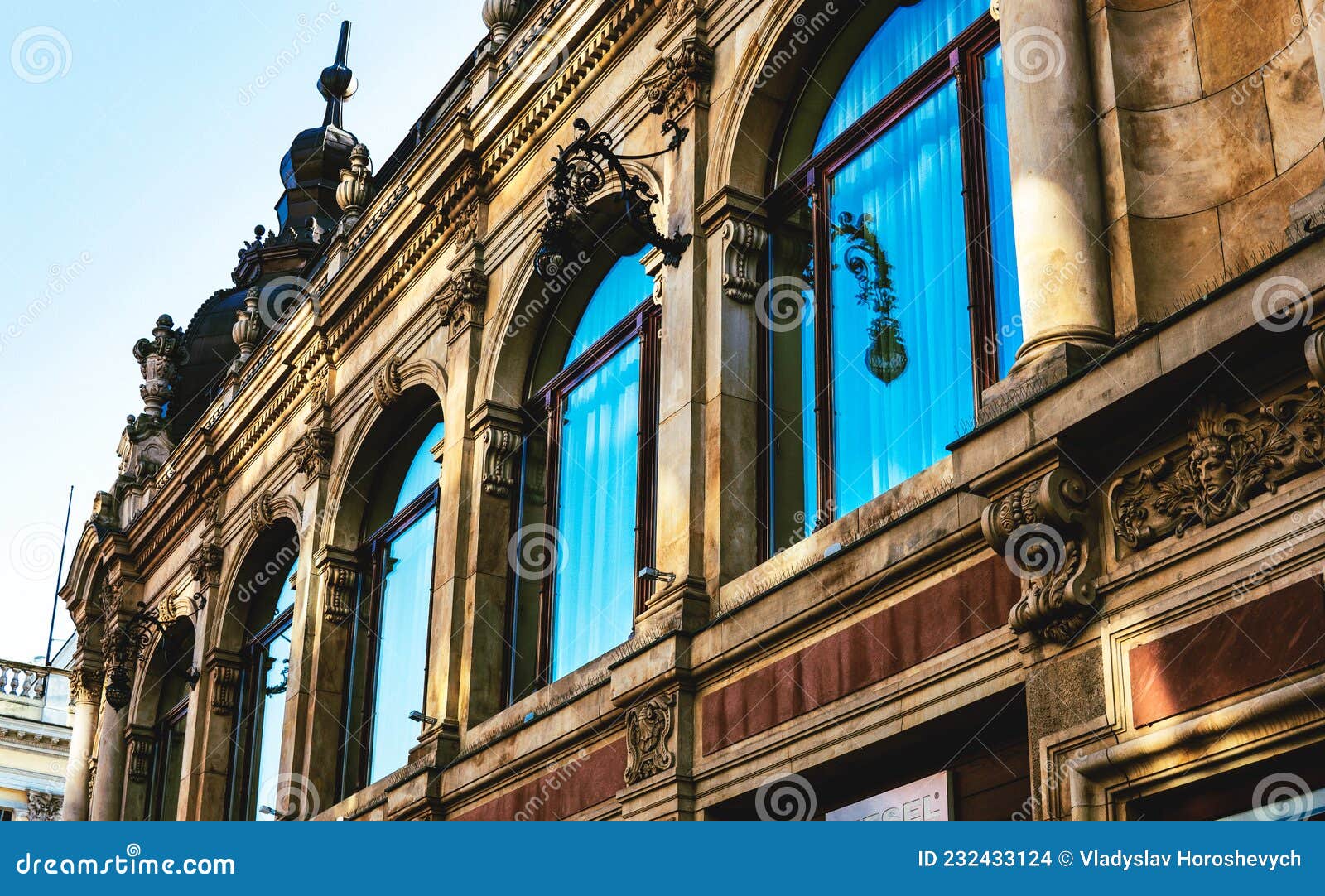 Vintage Large Windows Reflecting the Blue Sky. Facade of a Stone ...