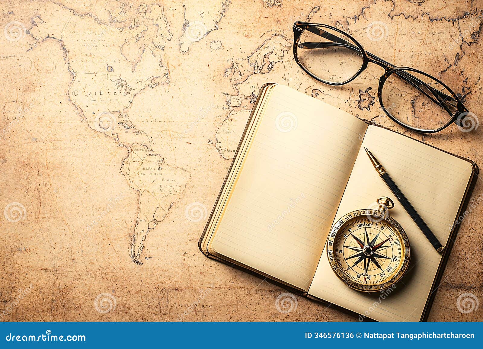 A Vintage Map Accompanied by an Open Journal, a Compass and Glasses ...
