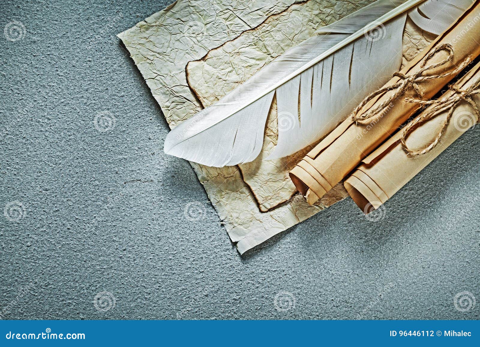 Vintage Paper Rolls Feather on Grey Background Stock Photo - Image of ...