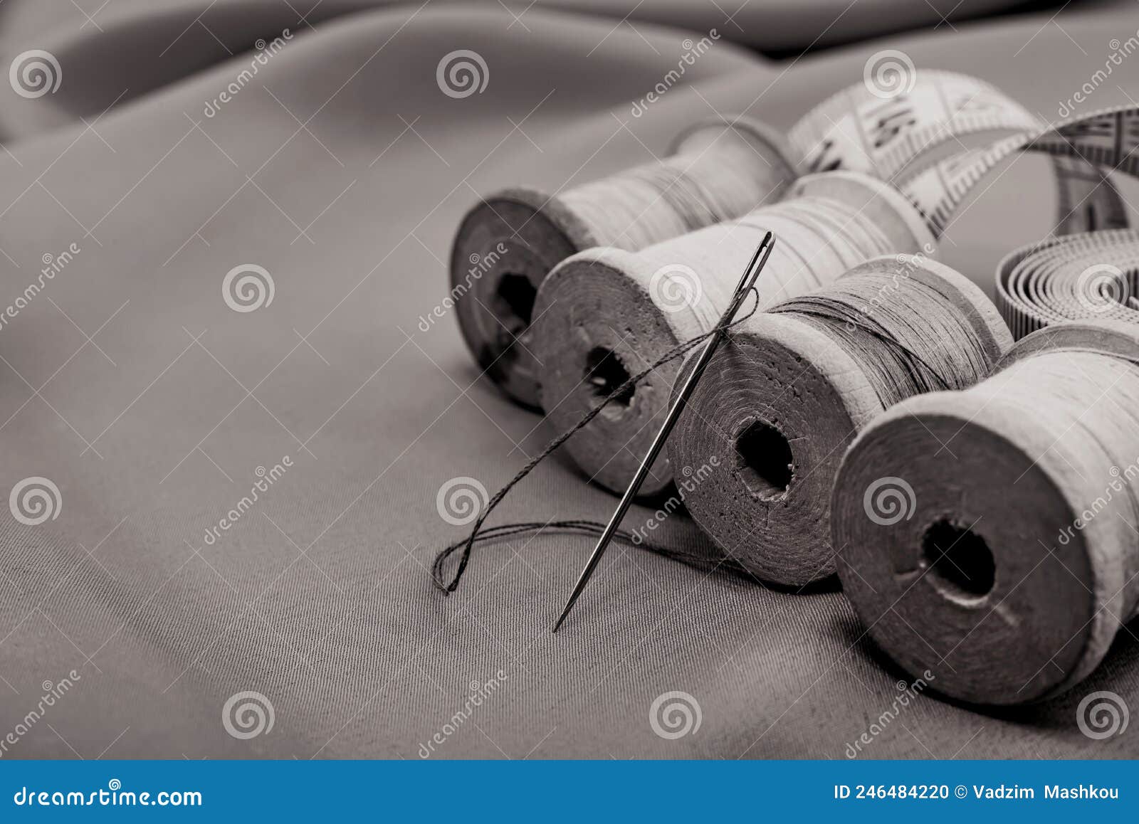 Vintage Retro Spool of Thread on a Black and White Fabric Background ...