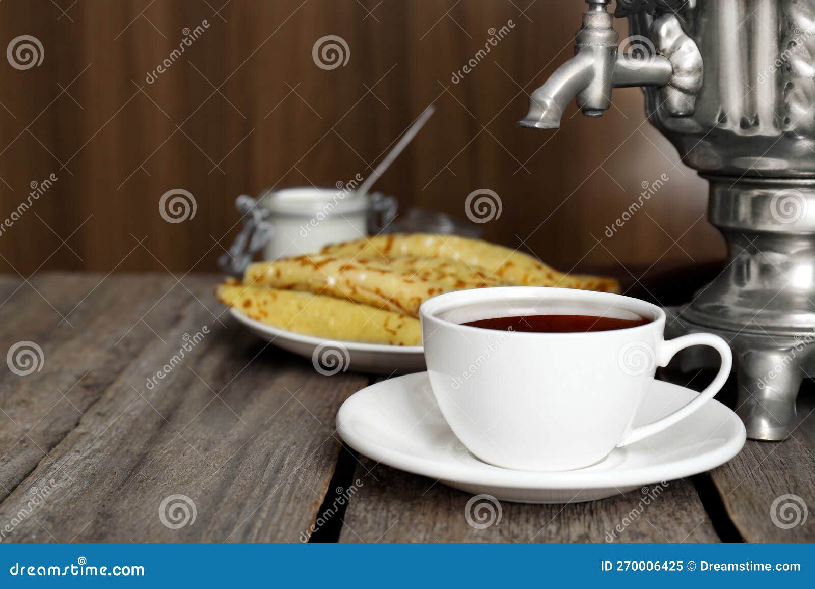Vintage Samovar Cup Of Hot Drink And Pancakes Served On Wooden Table