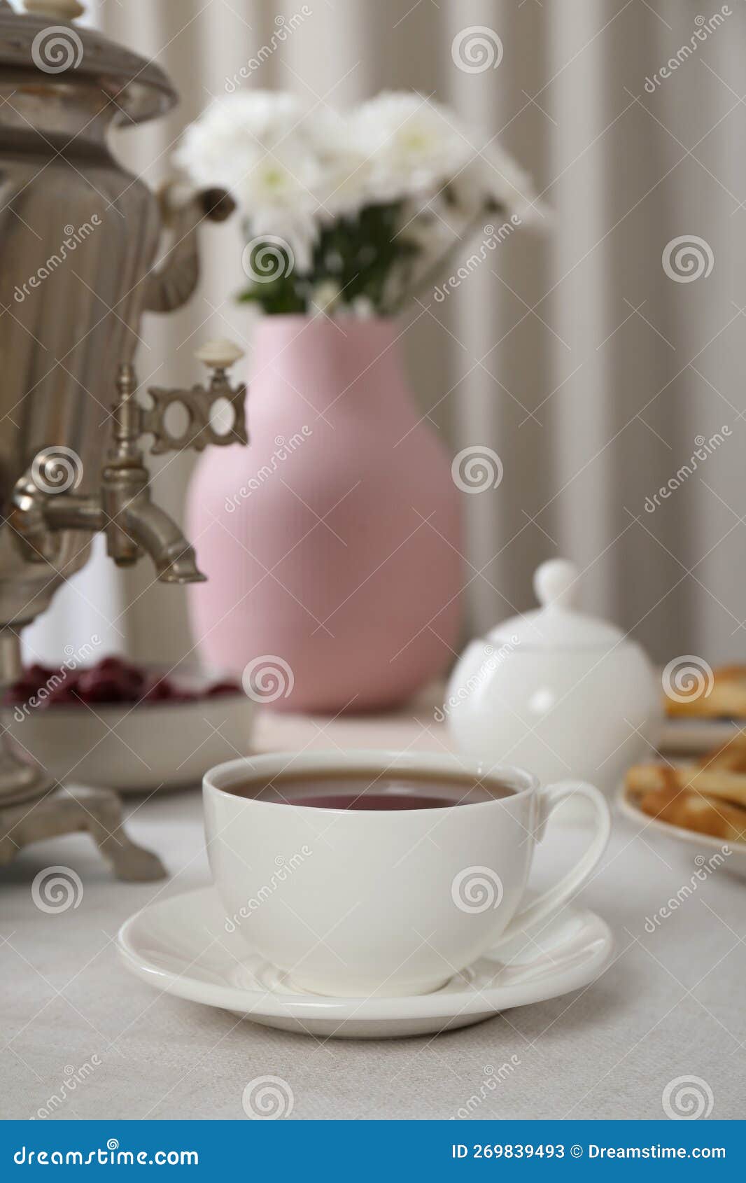 Vintage Samovar Cup Of Hot Drink And Snacks Served On Table Indoors