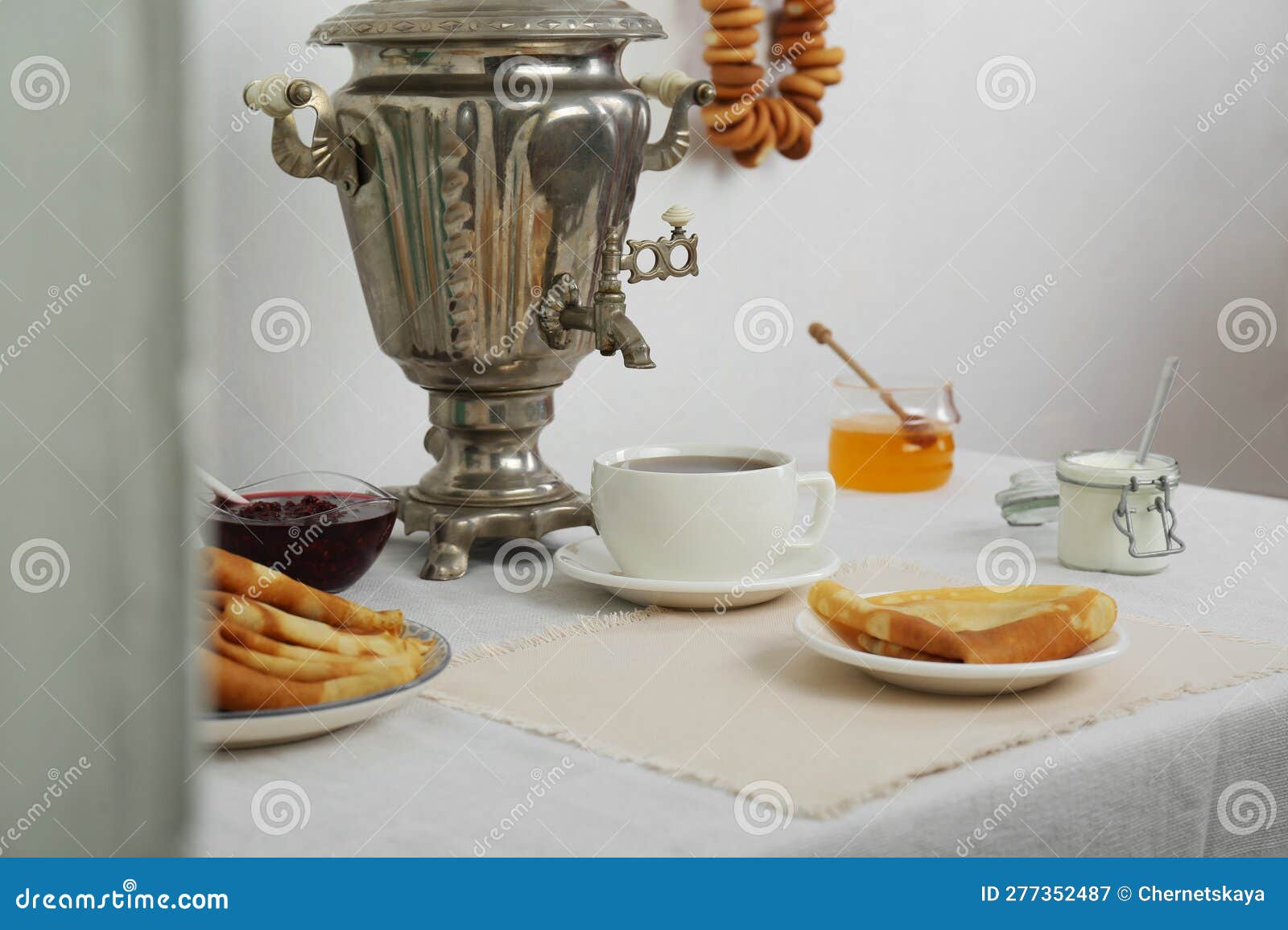 Vintage Samovar Cup Of Hot Drink And Snacks Served On Table Indoors