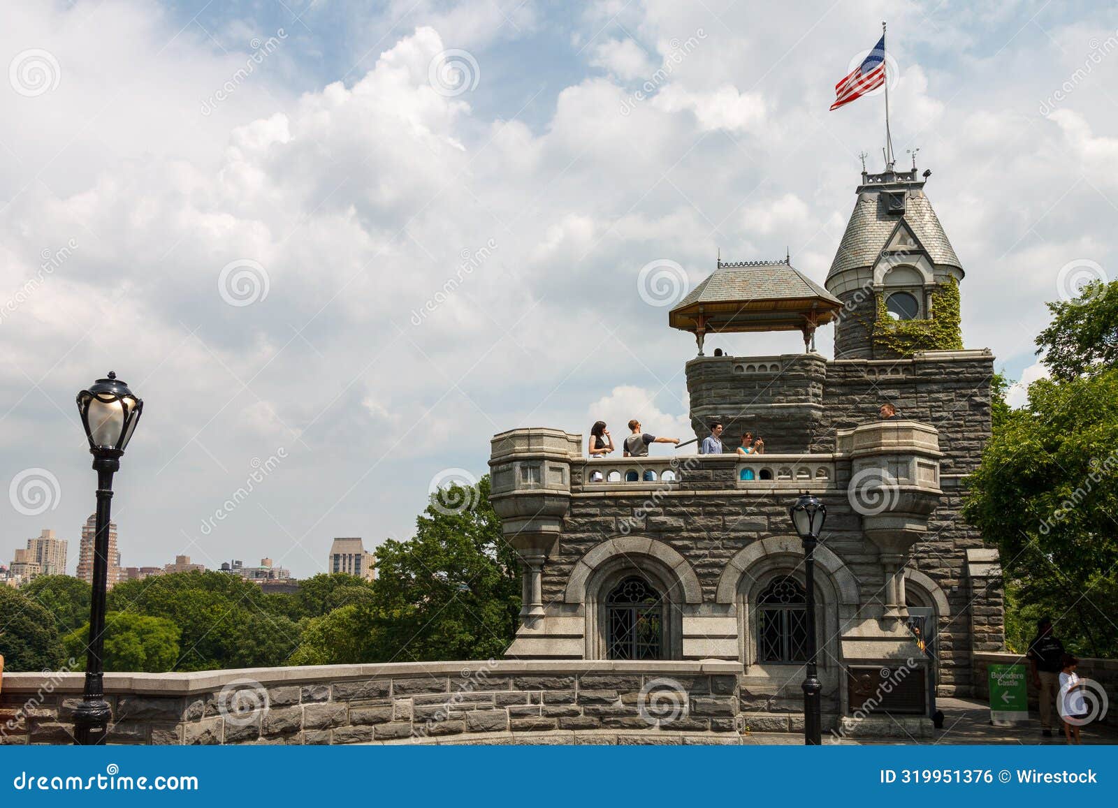 Vintage Stone Building with Clock Tower by Water and Lush Trees ...
