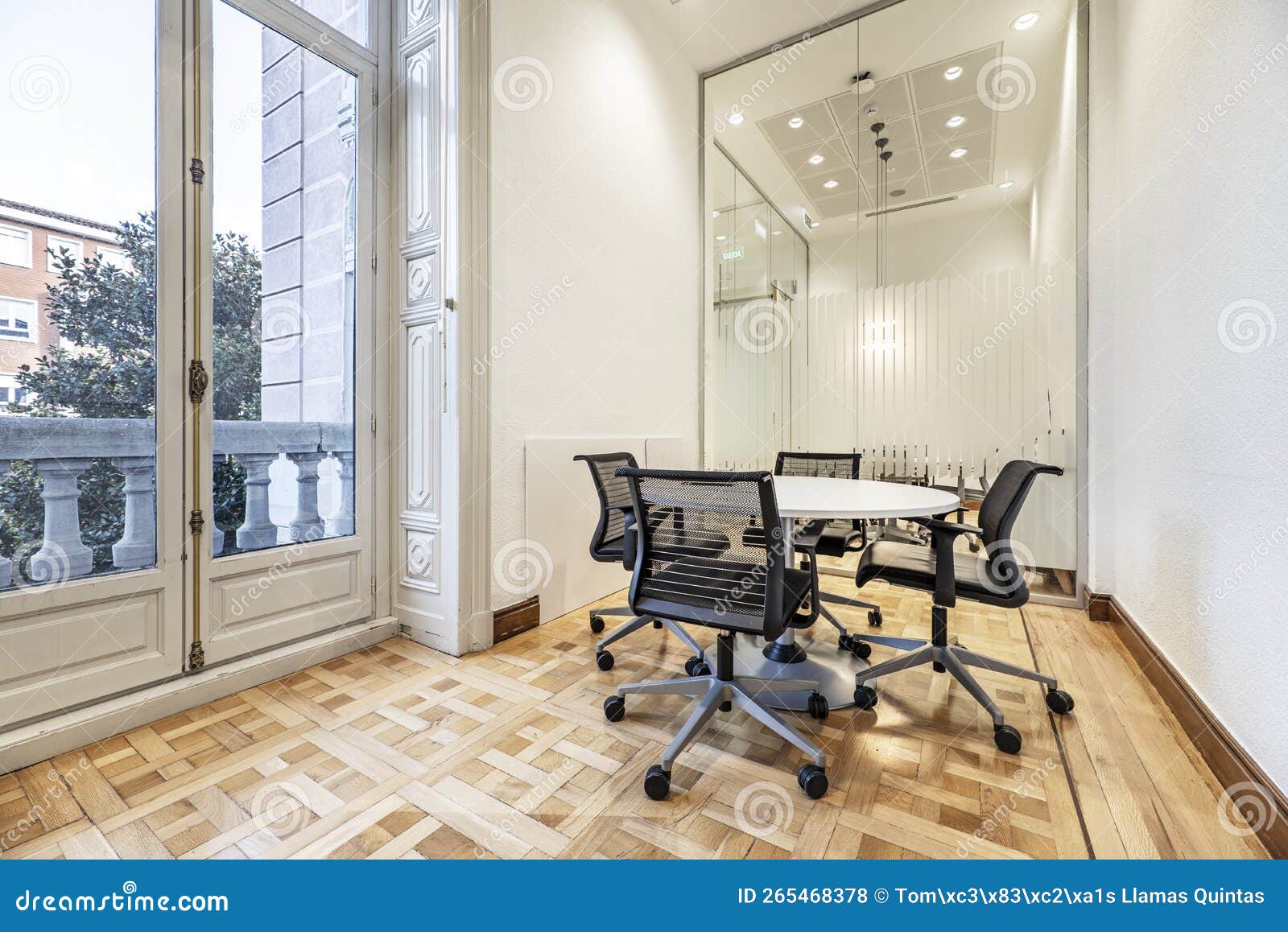 Vintage Style Building Office With Round Meeting Table Glass Partitions And Large Windows Stock