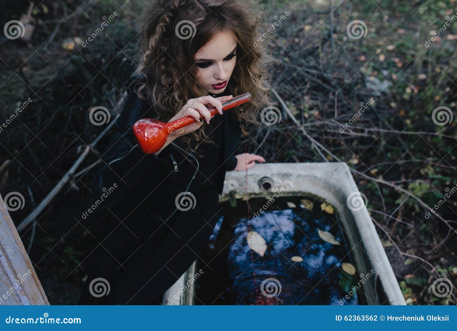 Vintage Witch with Elixir in Hand Stock Photo - Image of background ...