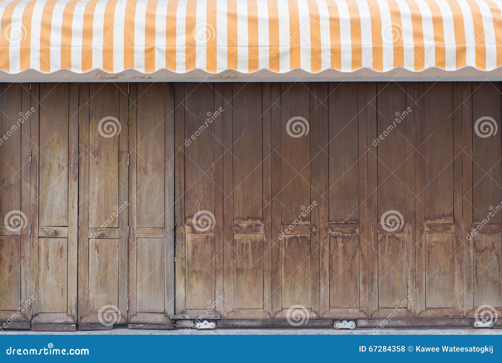 Vintage Wooden Gate with Yellow Stripe Awning Stock Photo - Image of ...