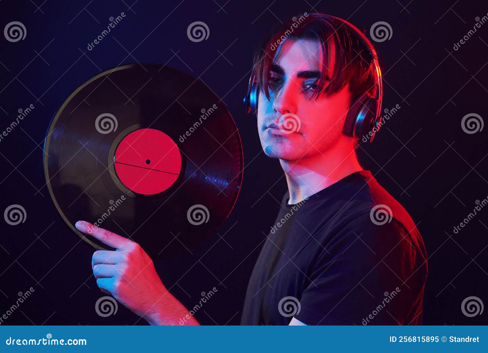 With Vinyl Record in Hands. Man Standing in the Studio with Neon Light ...