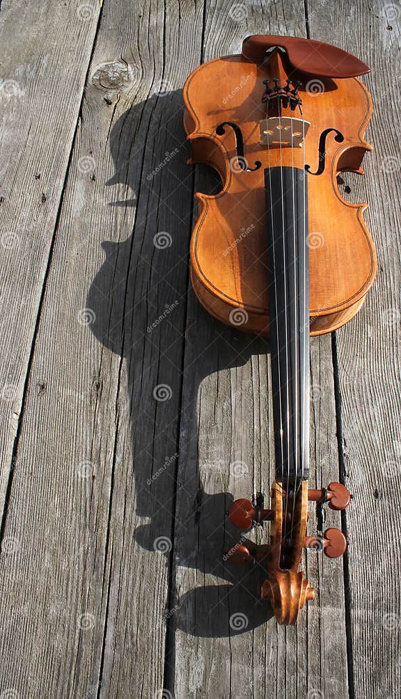 A Violin and its Shadow stock image. Image of table, strings - 59904275