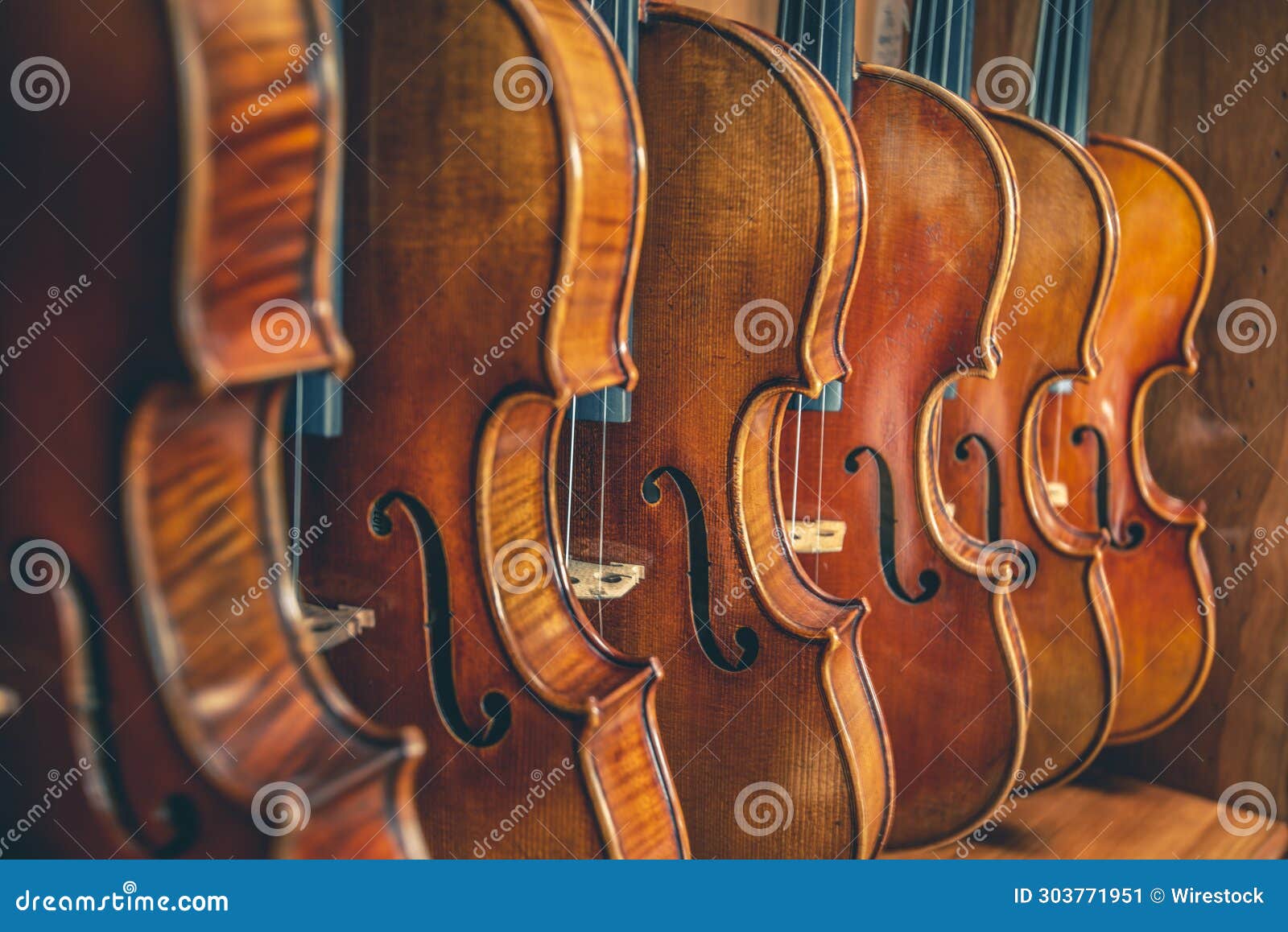 Row of Violins Arranged Neatly on a Stand in a Room. Stock Image ...