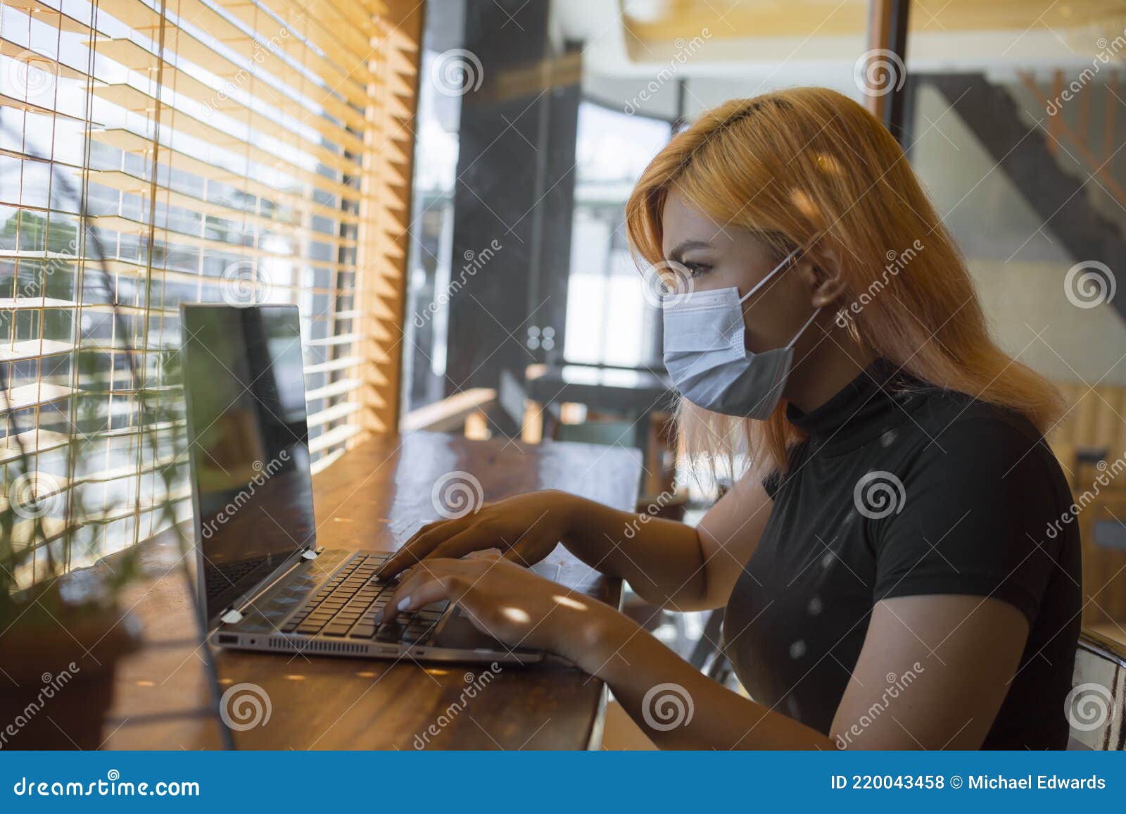 A Virtual Assistant with a Face Mask Working Remotely at an Uncrowded ...