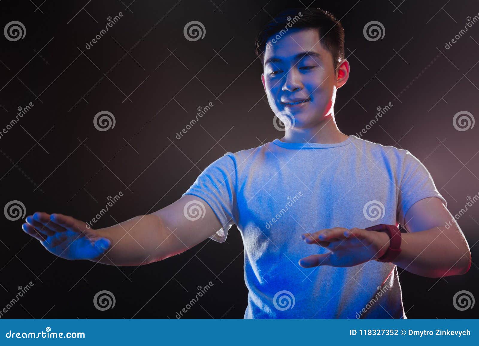 Pleasant Young Man Looking at His Hands Stock Photo - Image of ...