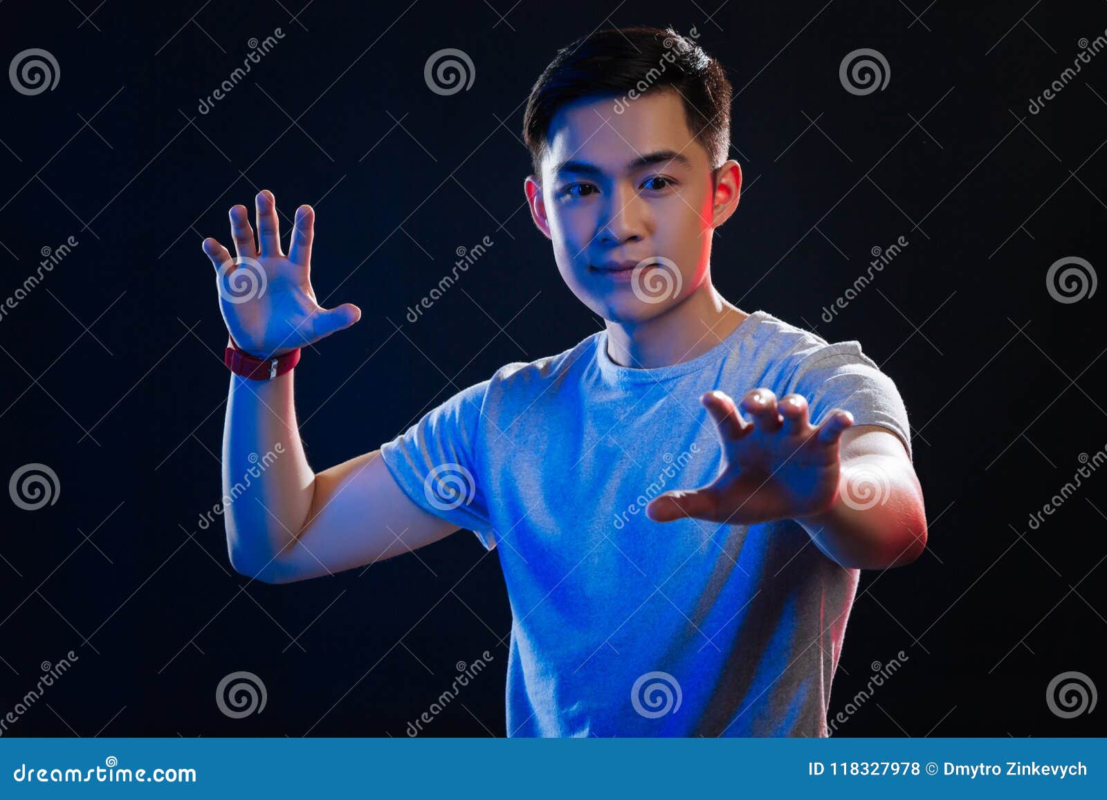 Positive Smart Man Looking at His Hand Stock Photo - Image of media ...