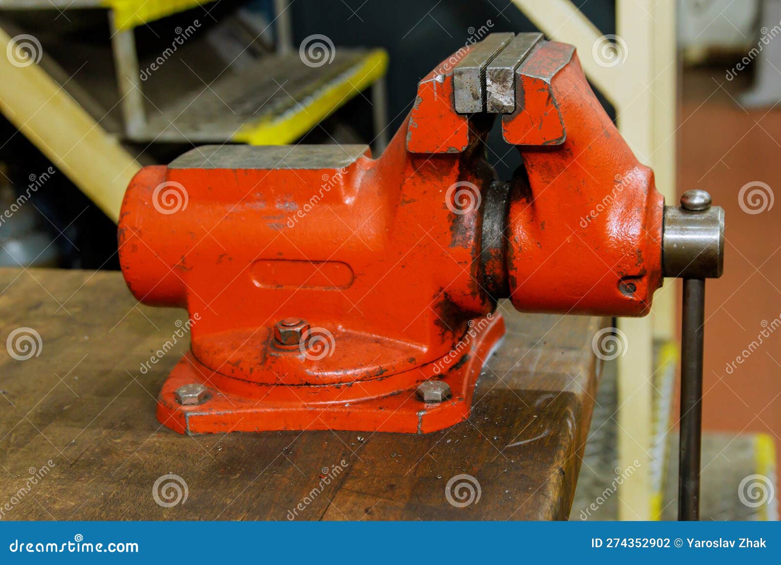 The Vise is Fixed on the Metalworking Workbench. Red Vise on a Wooden ...