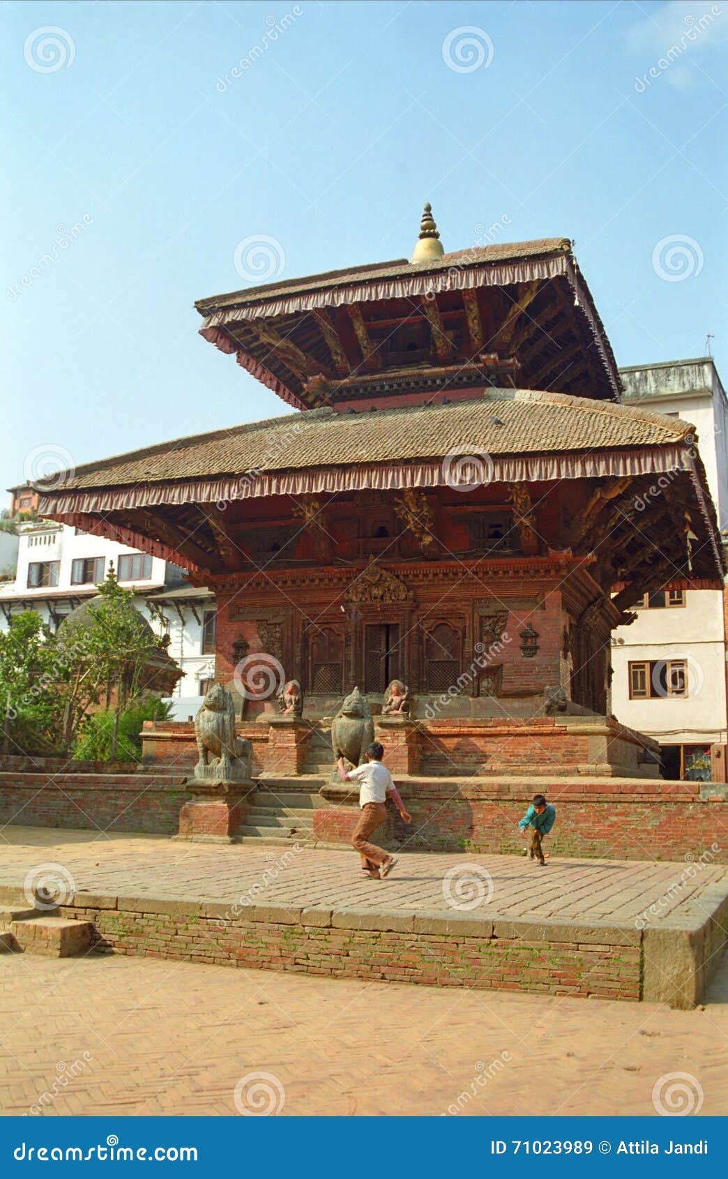 PATAN, NEPAL - DECEMBER 19, 2014: Garuda Statue On Column And Krishna ...