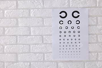 Vision Test Chart on White Brick Wall, Space for Text Stock Photo ...
