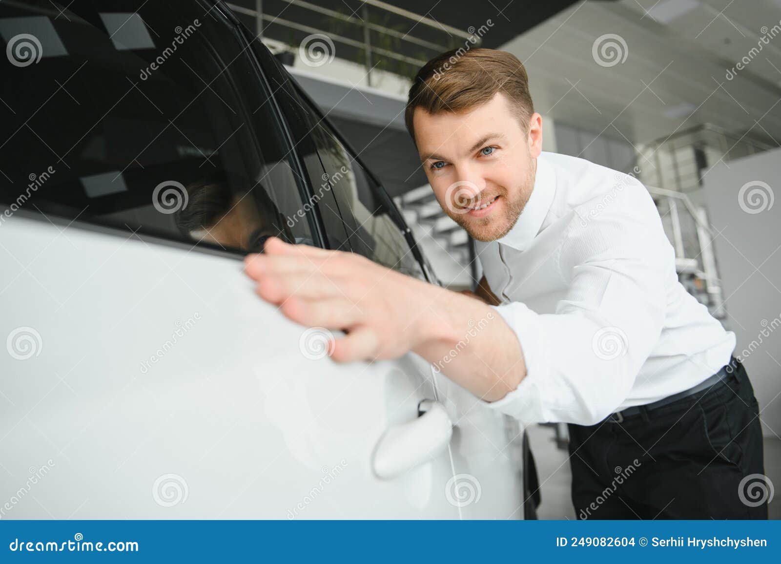Visiting Car Dealership. Handsome Bearded Man is Stroking His New Car ... Visiting Car Dealership. Handsome Bearded Man is Stroking His New Car ...