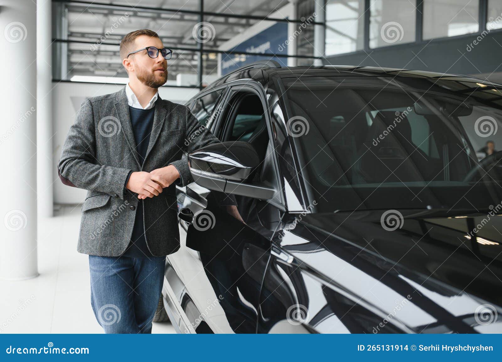 Visiting Car Dealership. Handsome Bearded Man is Stroking His New Car ... Visiting Car Dealership. Handsome Bearded Man is Stroking His New Car ...