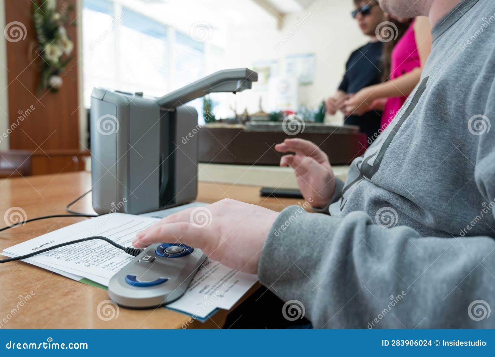 A Visually Impaired Man Uses a Scanning and Reading Machine. Stock ...