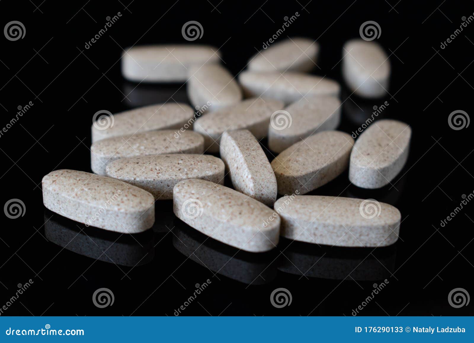 Vitamins in Large Tablets on a Black Glossy Surface Stock Image - Image ...