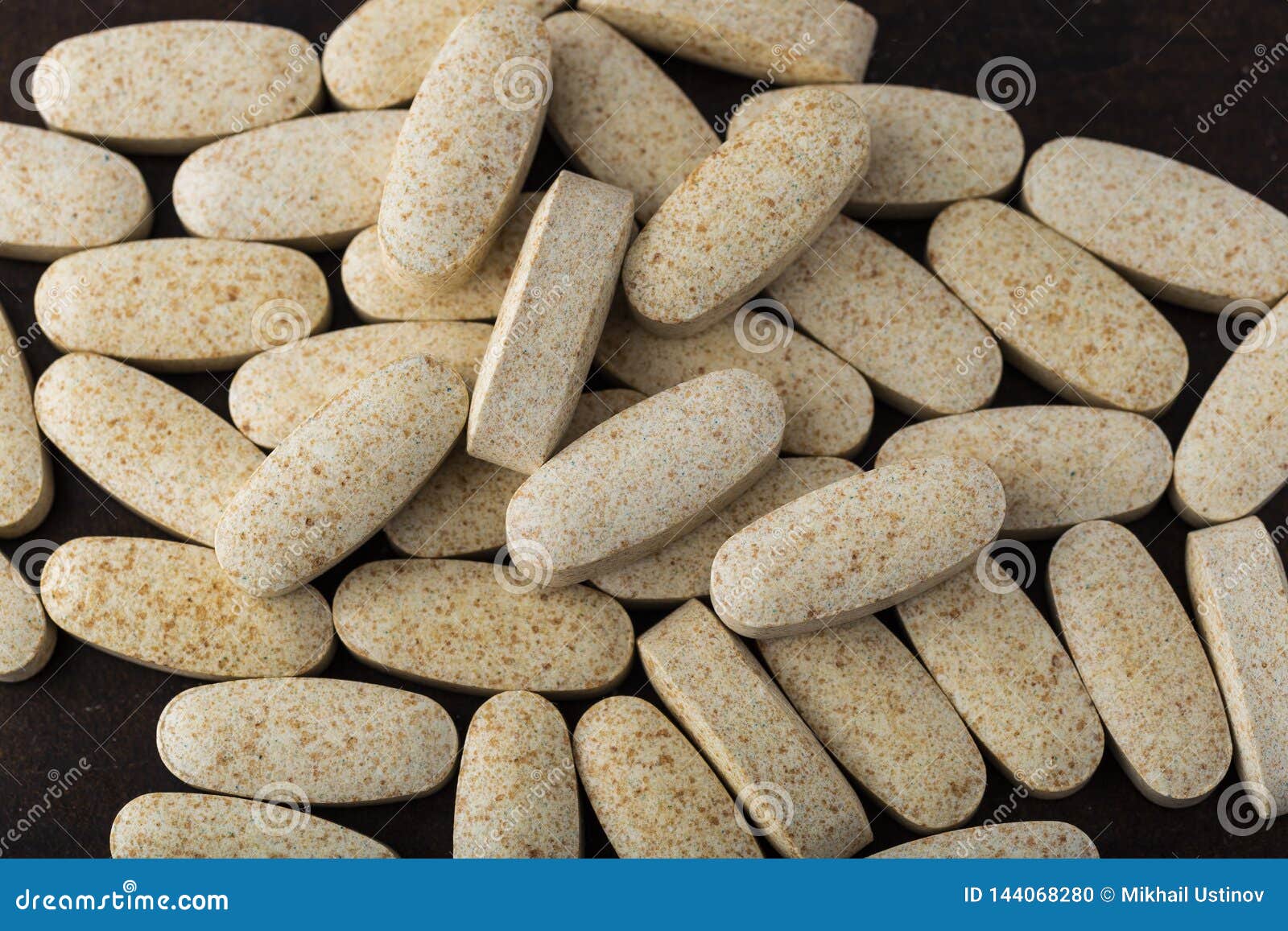 Vitamins in oval capsules stock photo. Image of brown - 144068280