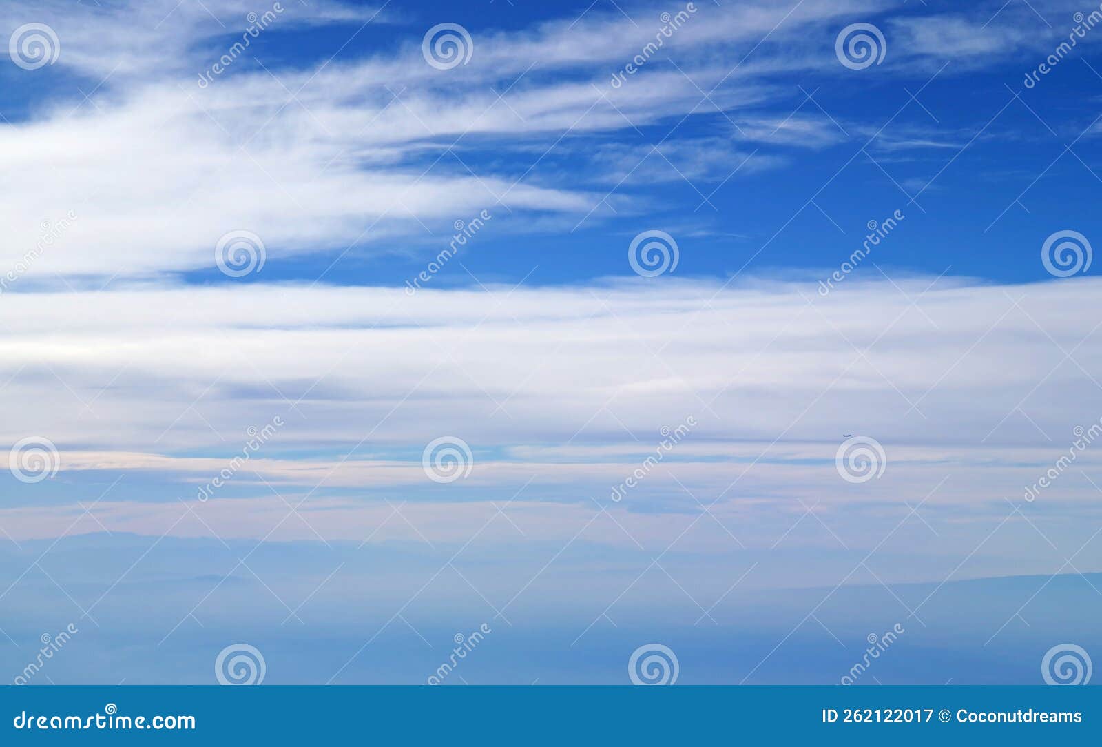 Blue Sky and White Spreading Clouds with an Airplane Flying in Distance ...