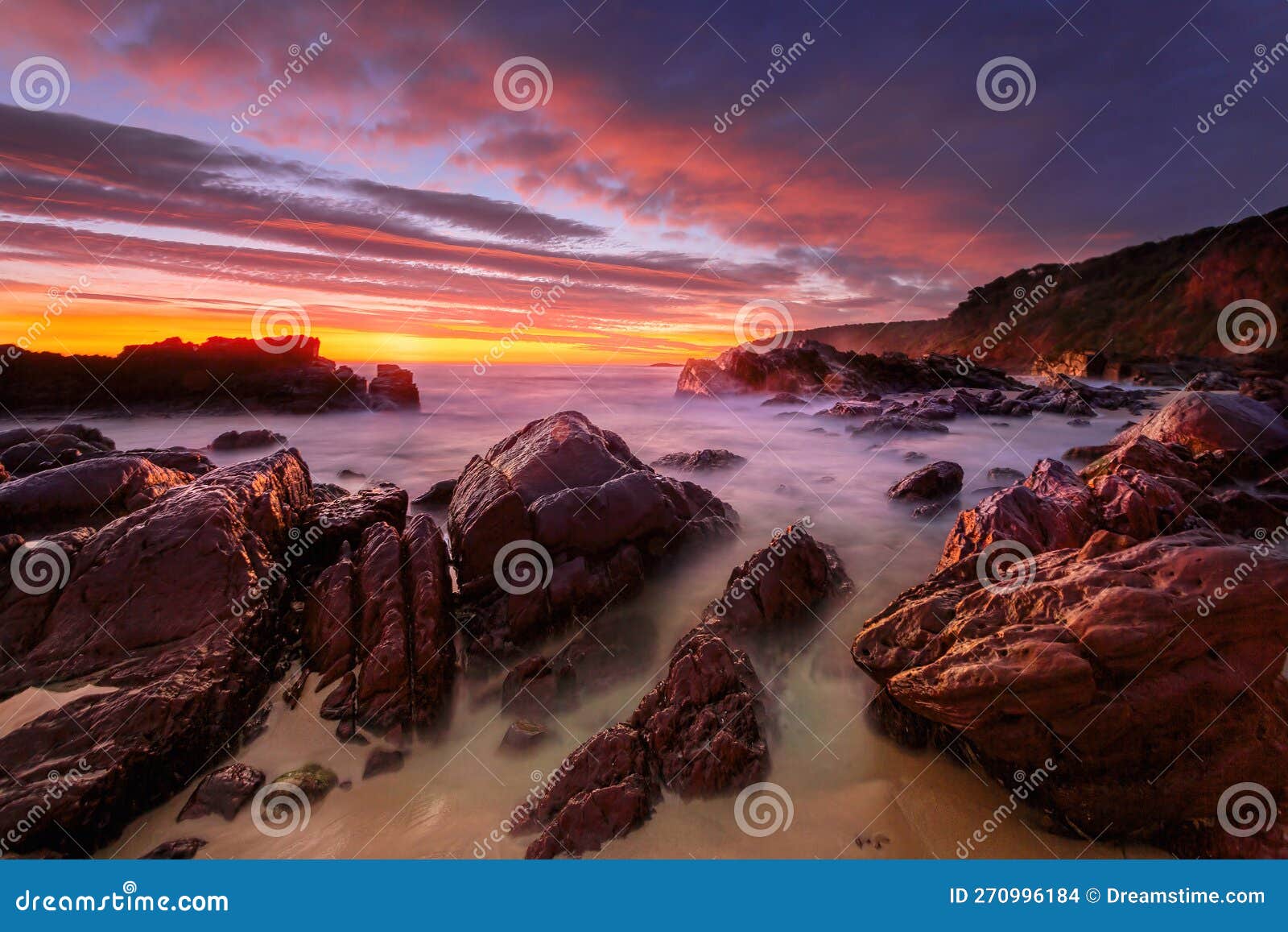 Vivid Red Sunrise Over Rocky Beach Coast Stock Photo - Image of ...