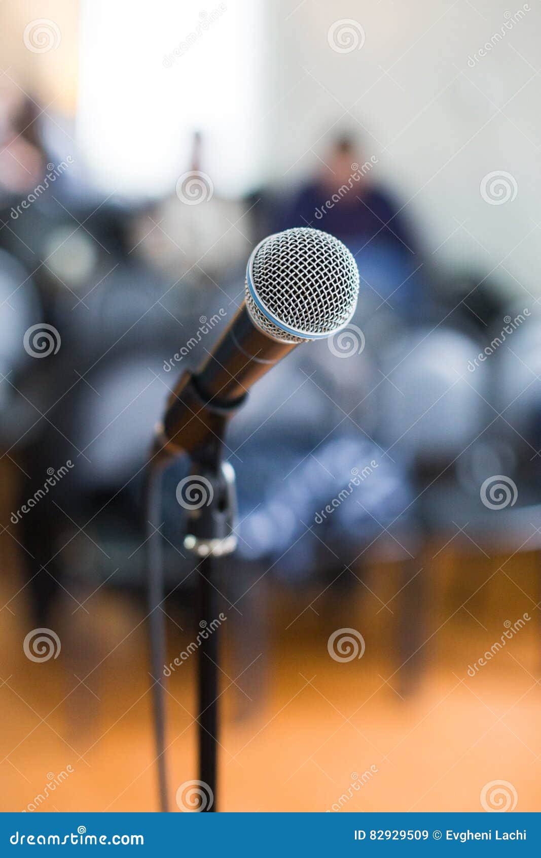 Vocal Microphone in Focus Against Blurred Audience at the Conference ...