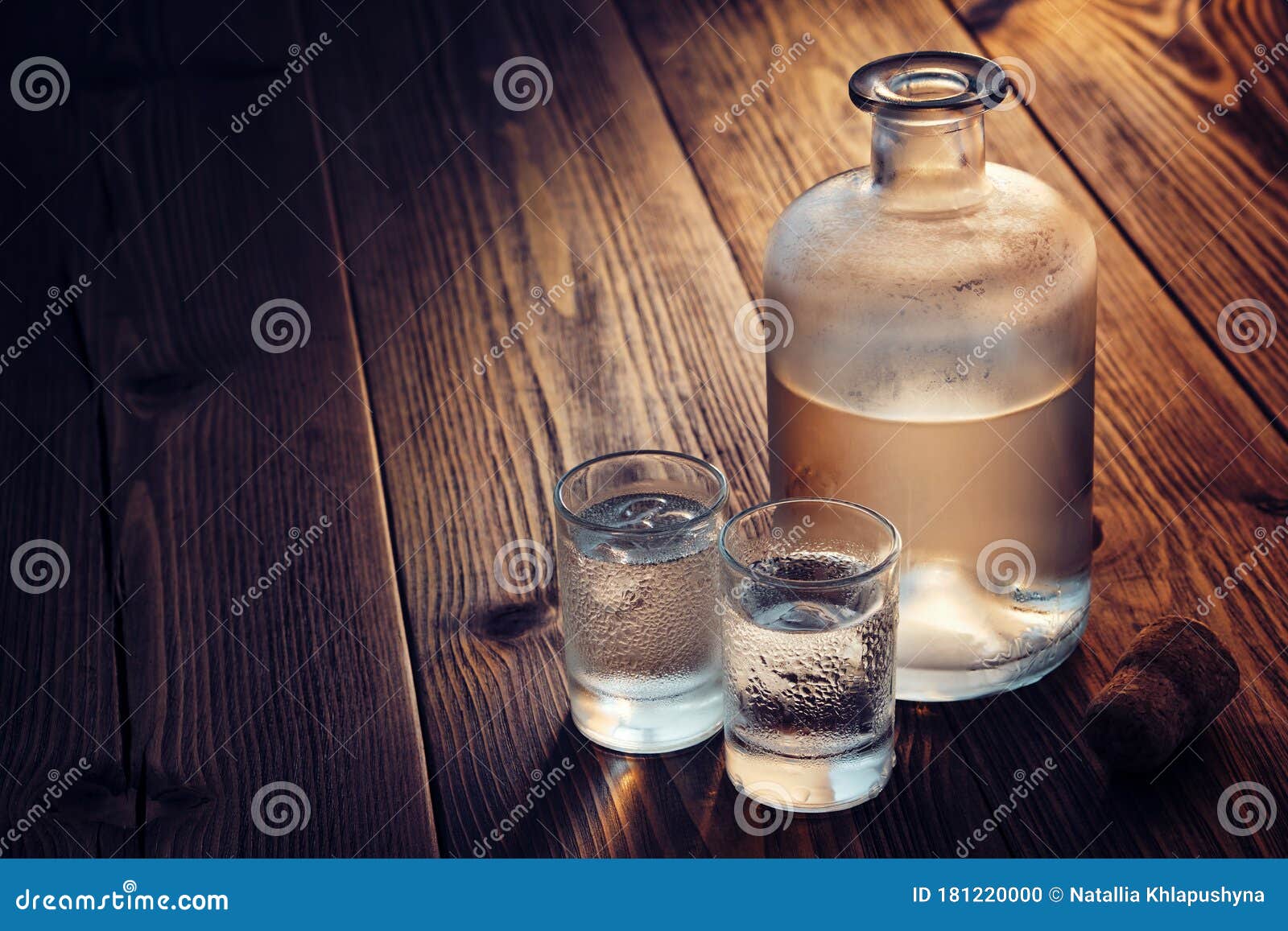 Vodka Bottle and Two Glasses of Vodka with Ice on a Table Stock Photo ...