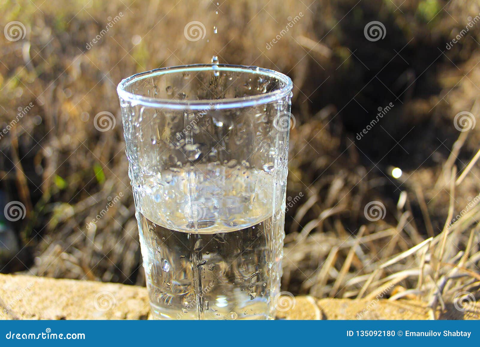 Vodka Drops Drip into a Clear Glass. Vodka in a Glass Against the ...