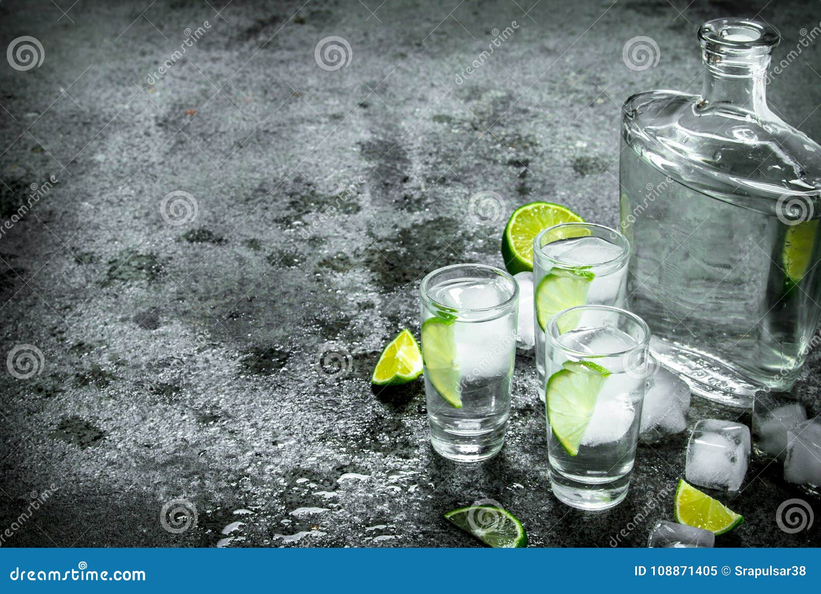 Vodka with Pieces of Lime and Ice Cubes. Stock Image - Image of alcohol ...