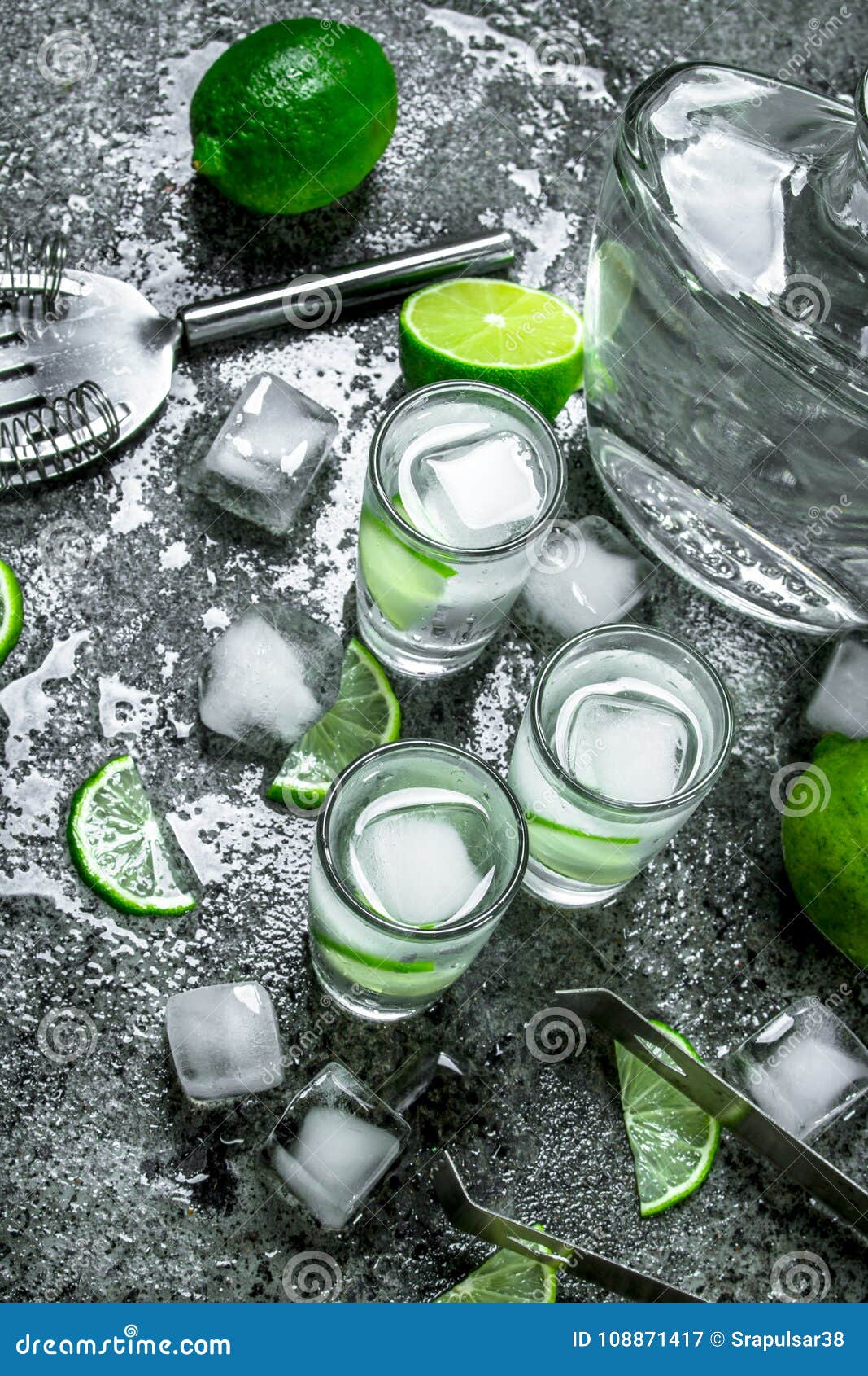 Vodka with Pieces of Lime and Ice Cubes. Stock Image - Image of black ...