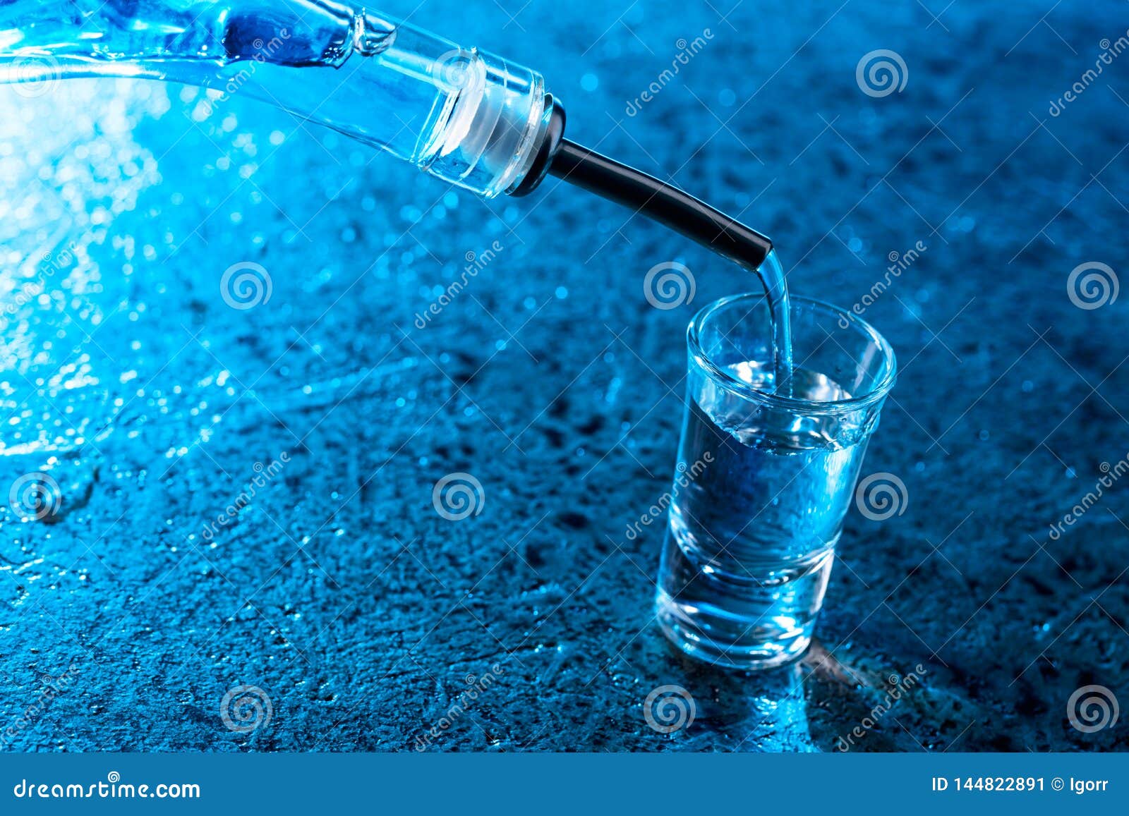 Vodka Poured into a Glass Lit with Blue Backlight Stock Image - Image ...