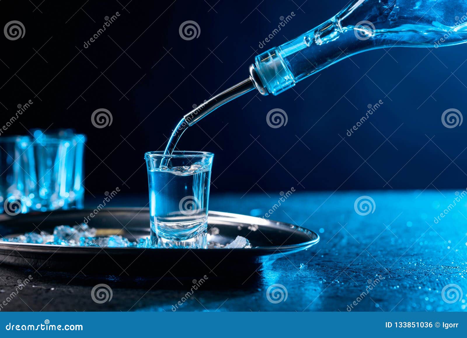 Vodka Poured into a Glass Lit with Blue Backlight Stock Photo - Image ...