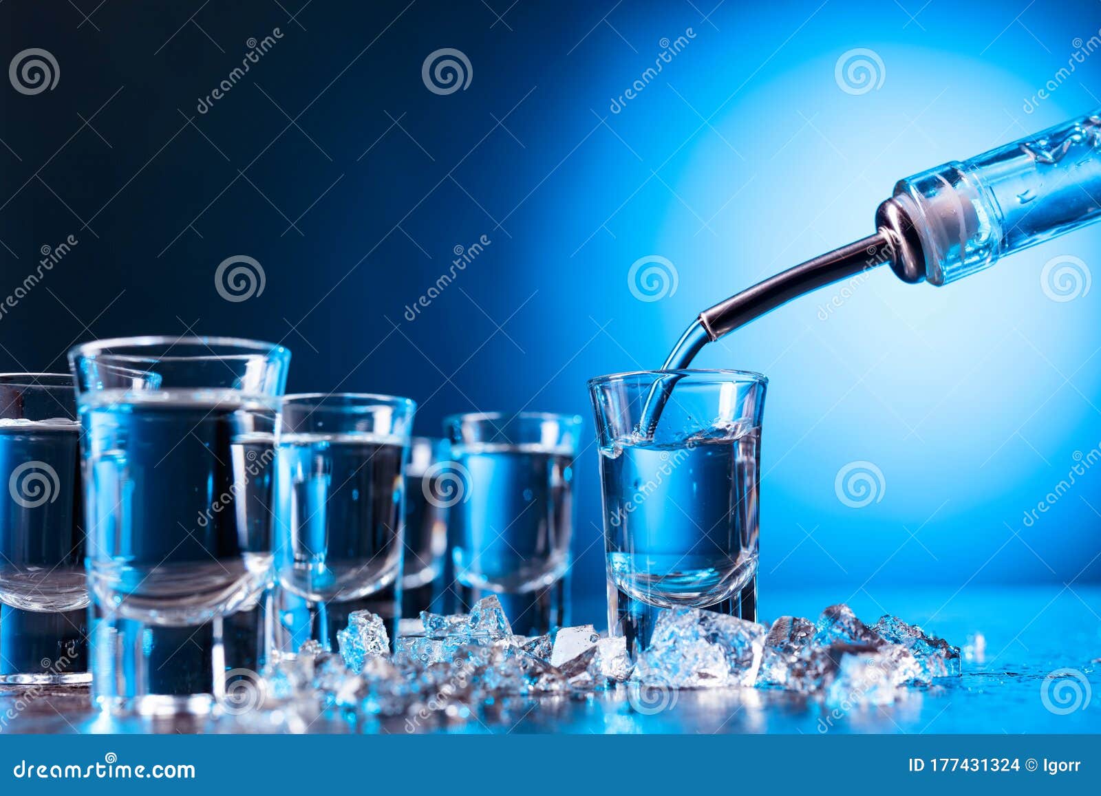 Vodka Poured into a Glass Lit with Blue Backlight Stock Photo - Image ...